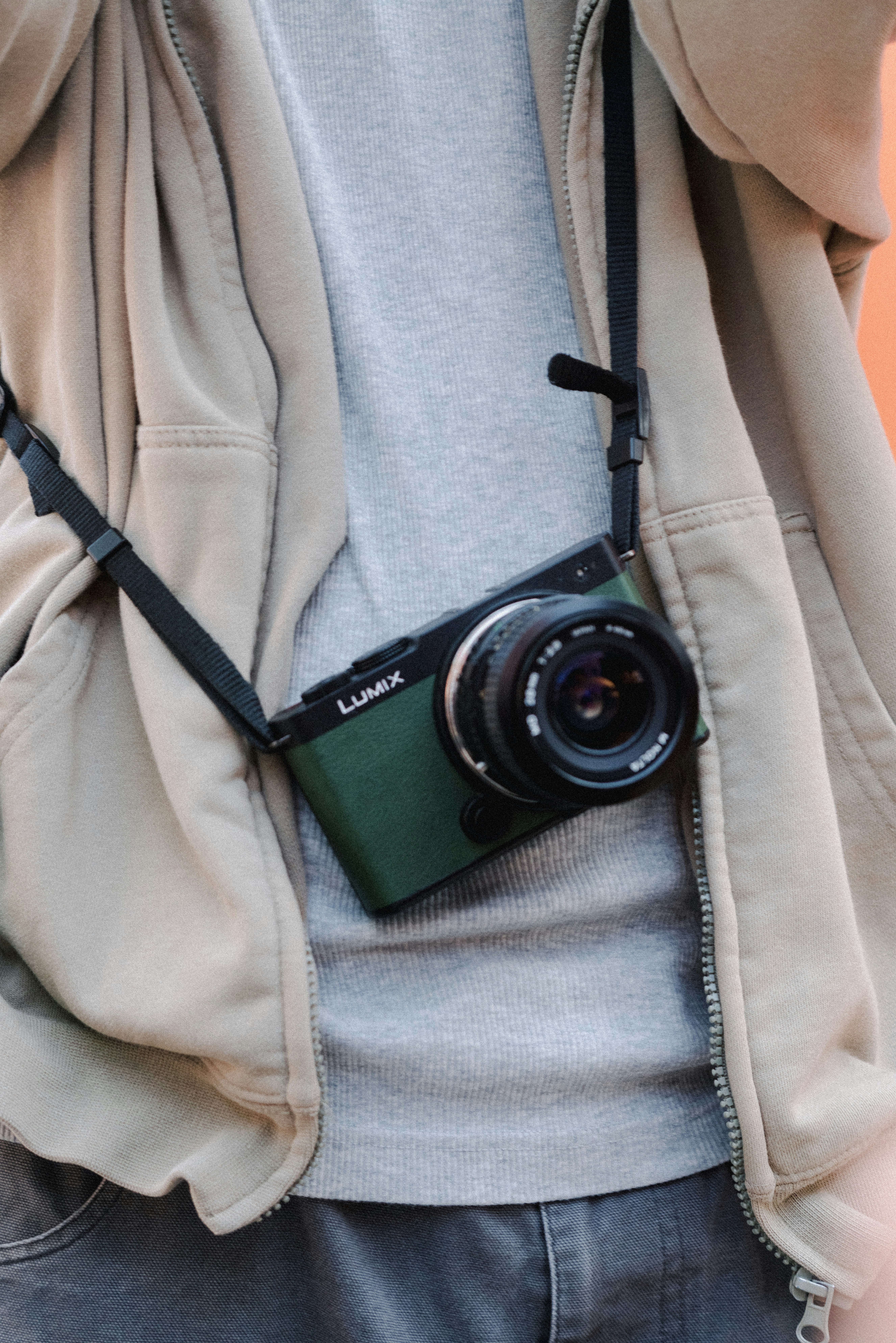 Compact Lumix, Big Moment: A Street-Ready Camera Resting at the Chest