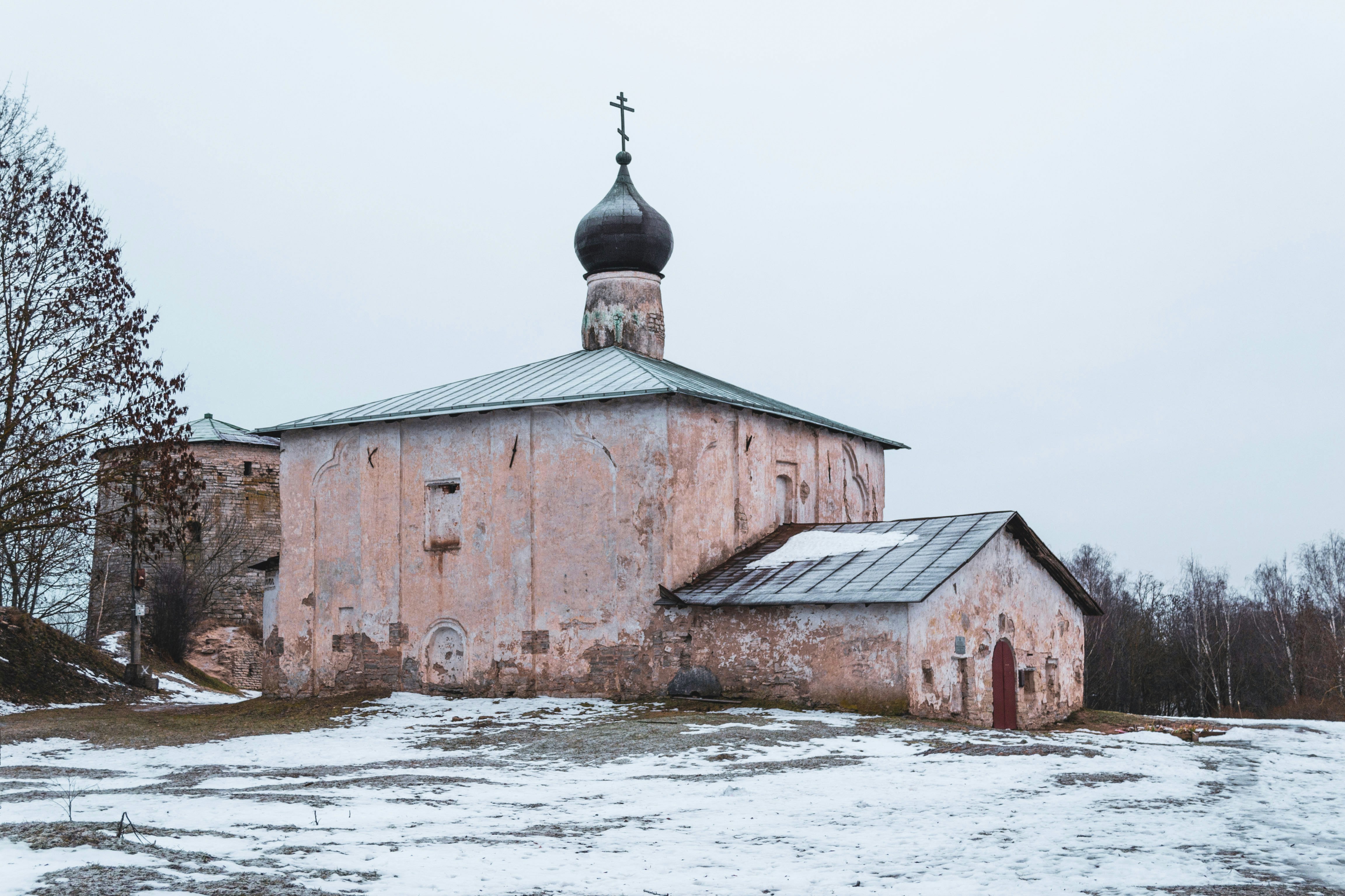 Weathered Orthodox Church on Snow-Kissed Plain