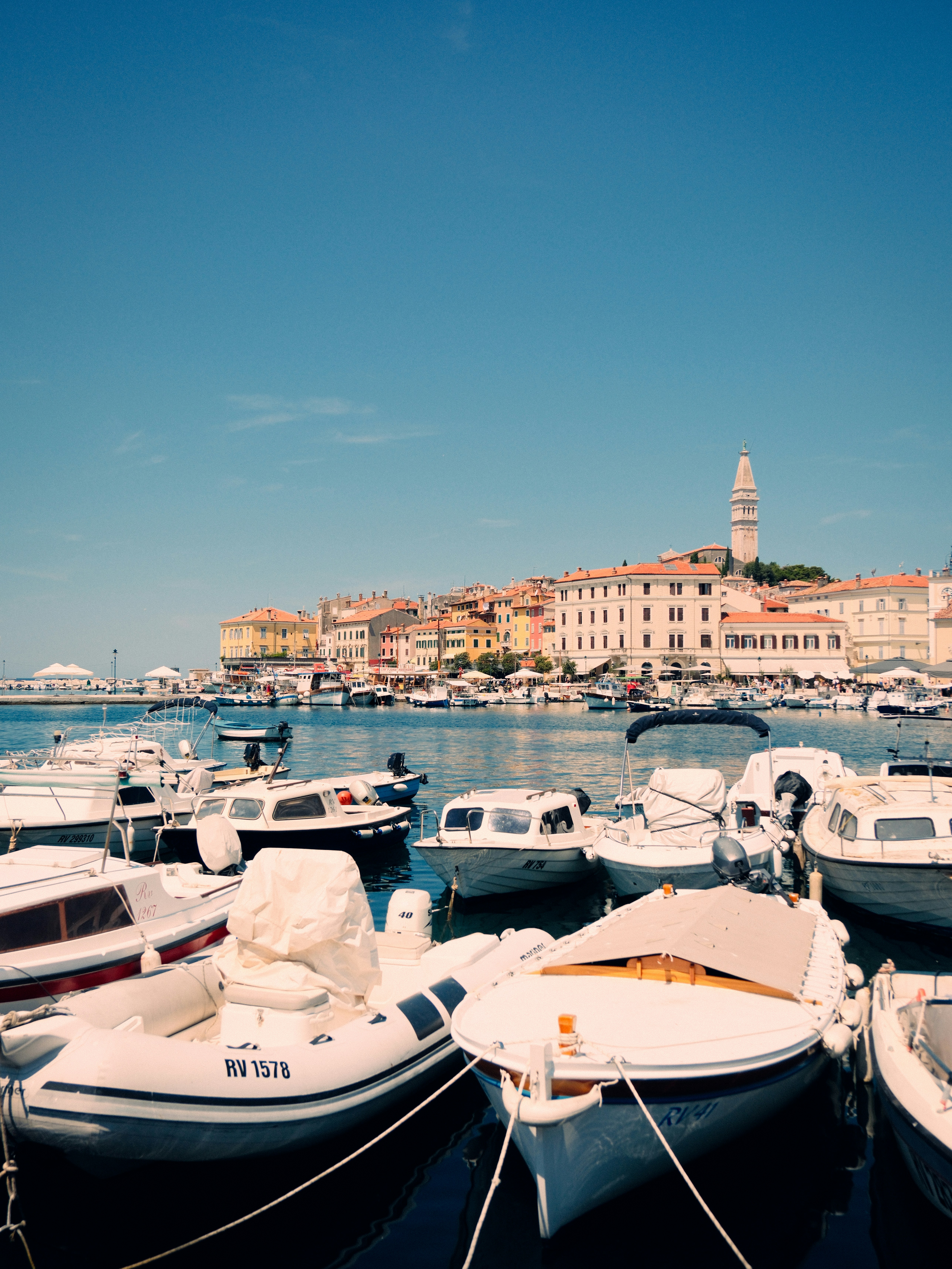 Harbor Silhouettes: Boats Docked Along a sunlit Italian Waterfront