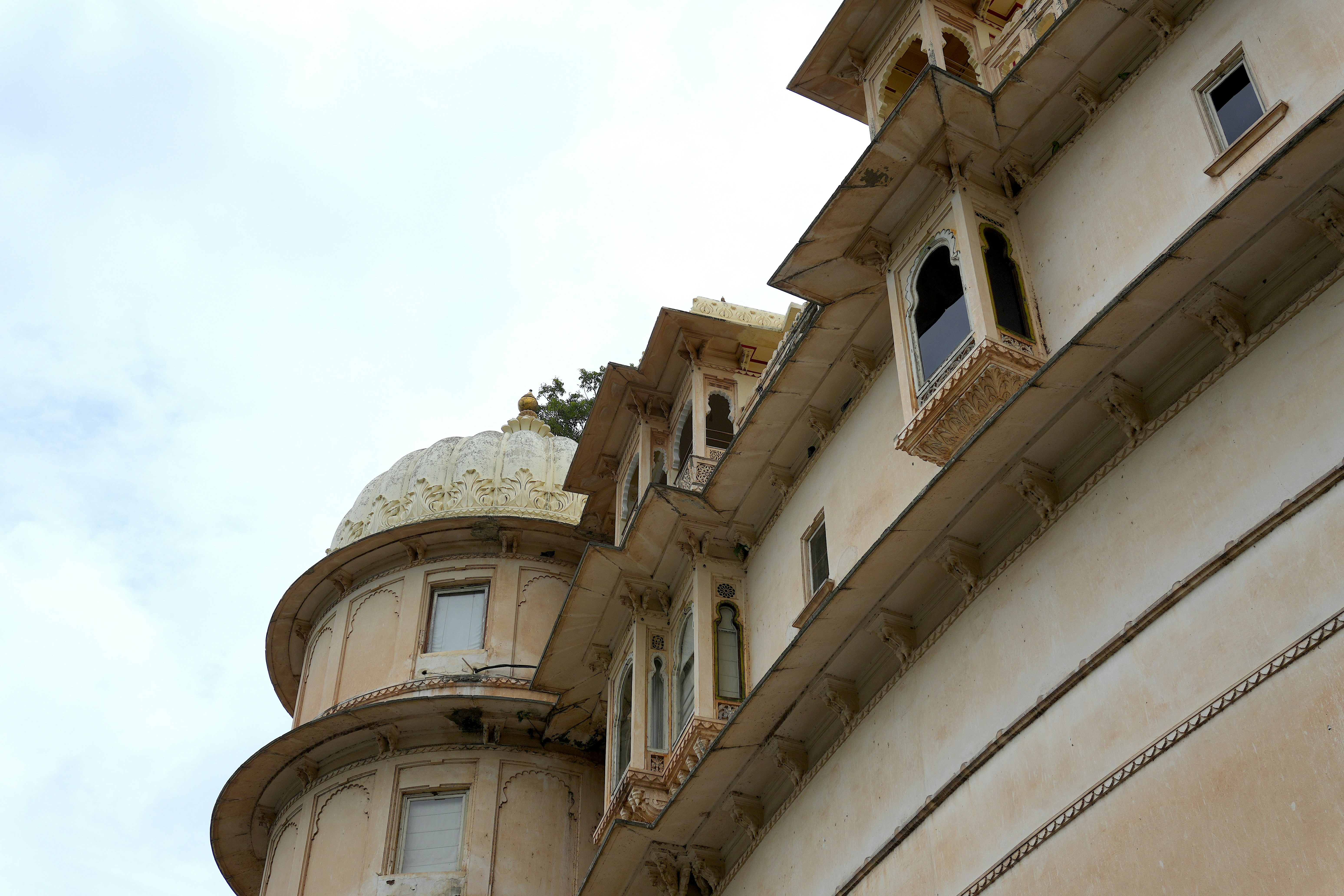 Ornate Balcony Gables Against a Pale Sky
