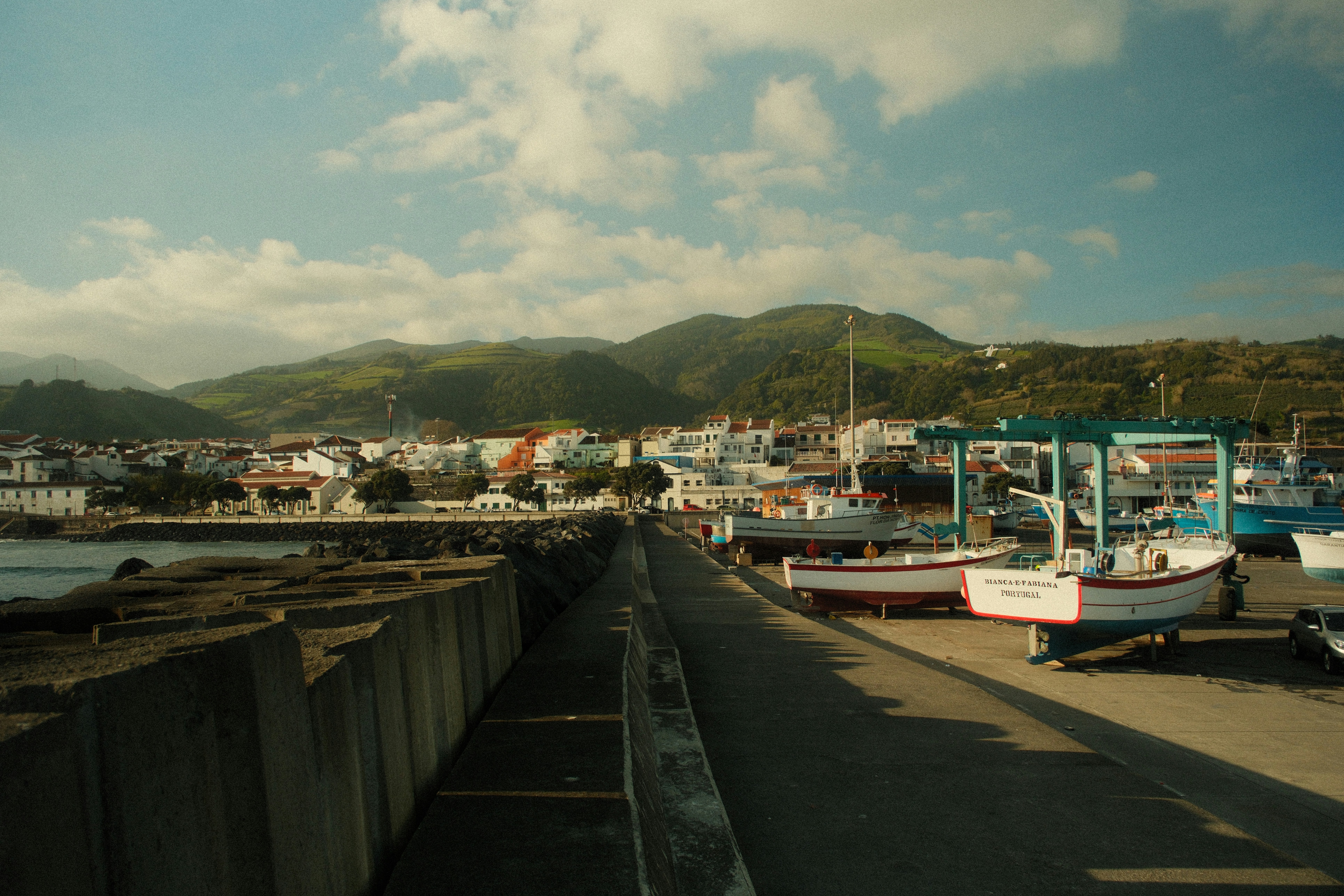 Harbor Avenue: Boats Rest Along a Quiet Pier with Distant Hills