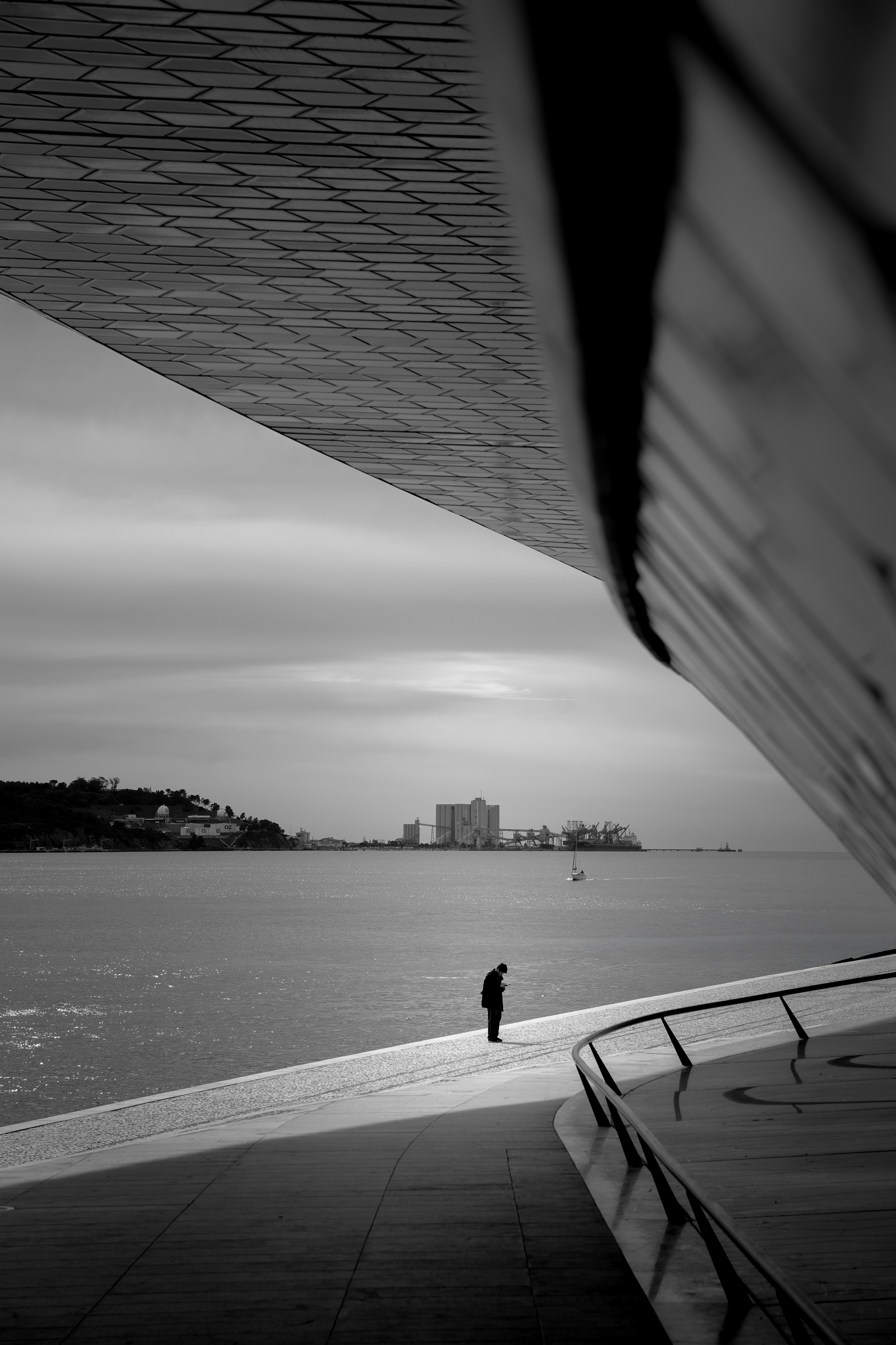 Person under modern architecture by lisbon river