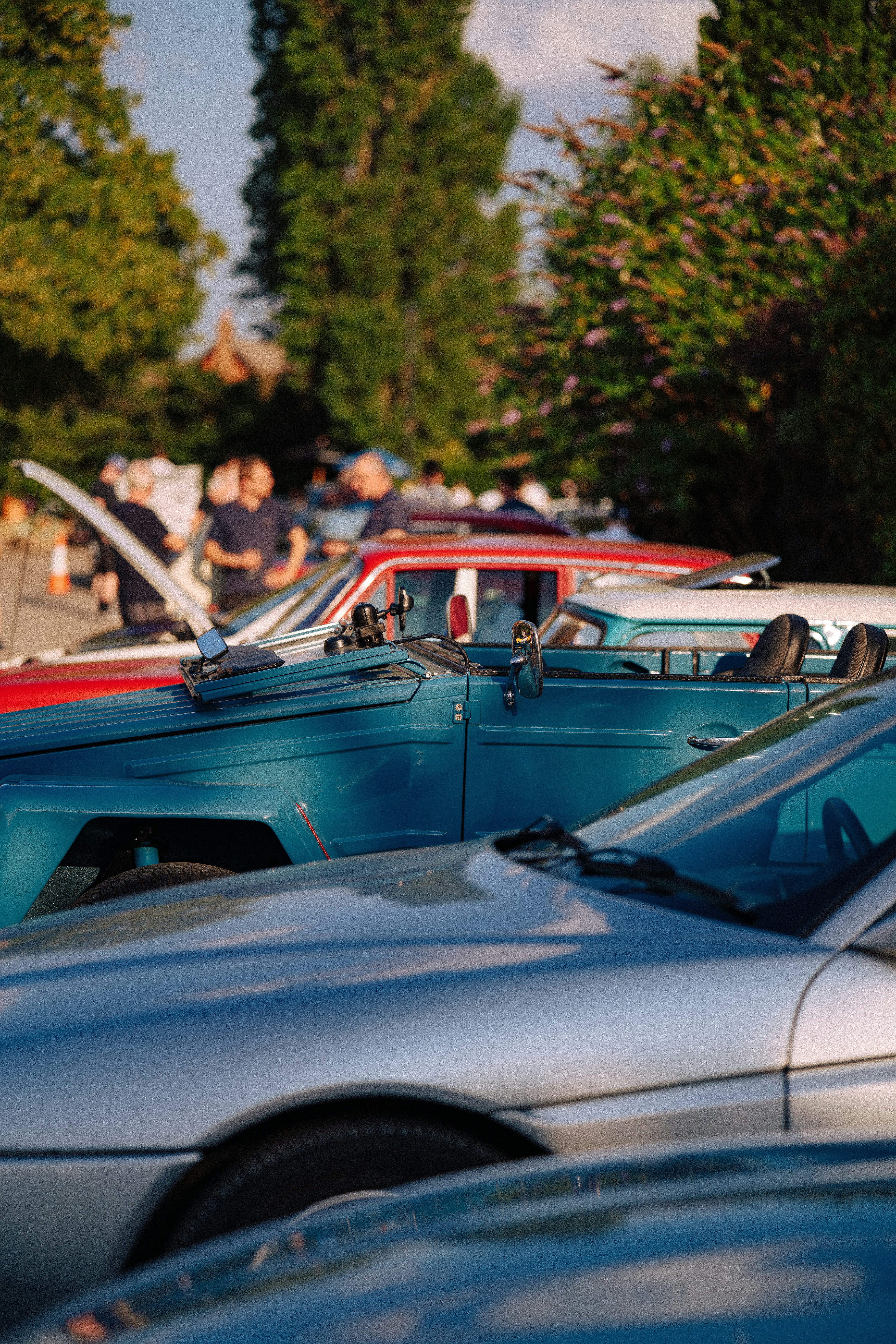 Sunlit Car Concours: A Row of Vintage Convertibles in Focus