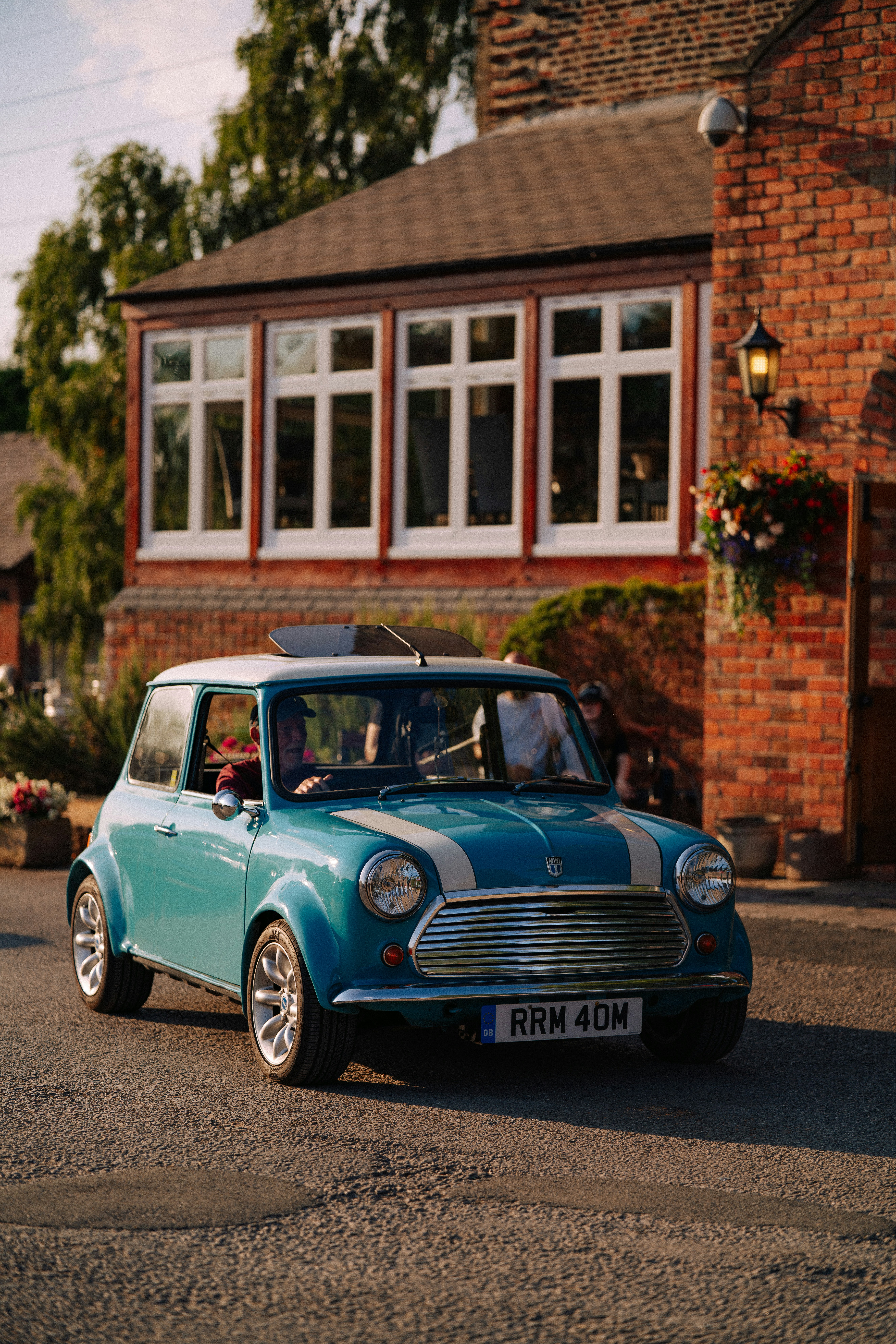 Blue Mini Cooper at the Village Doorstep