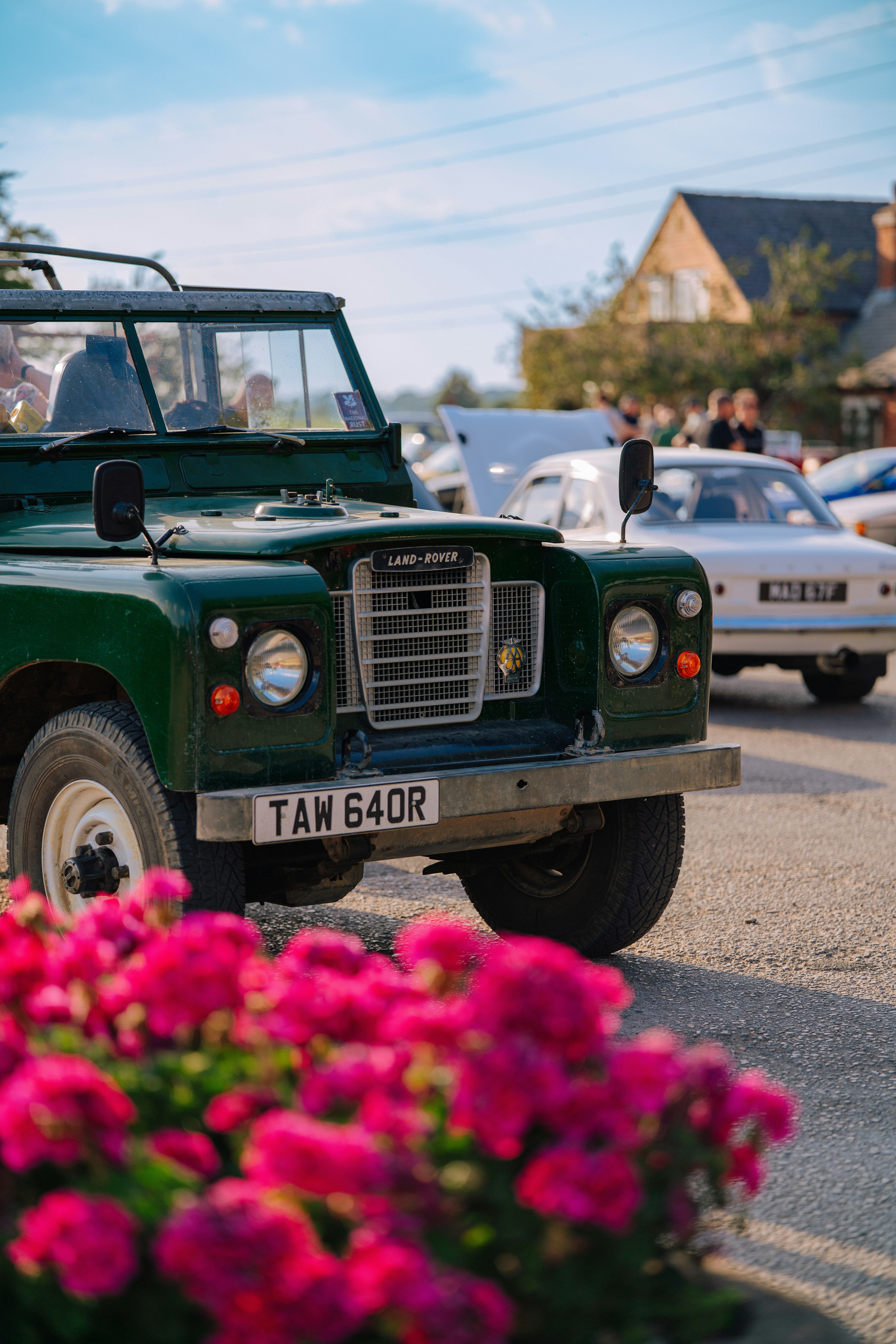 Green Land Rover at a Flower-Front Rally