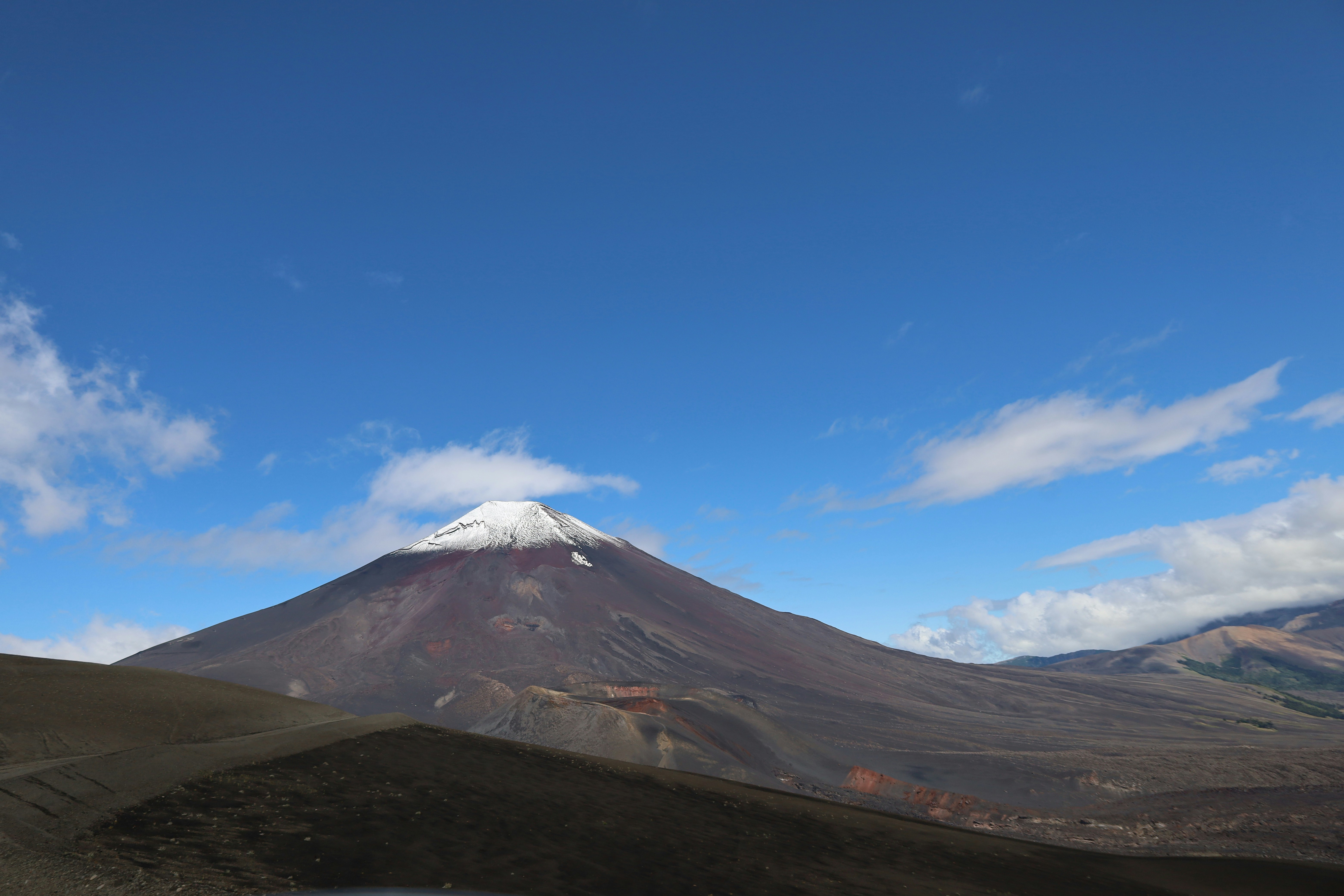 Snow-capped Peak Quietly Reigns Over a Desolate Lava Field