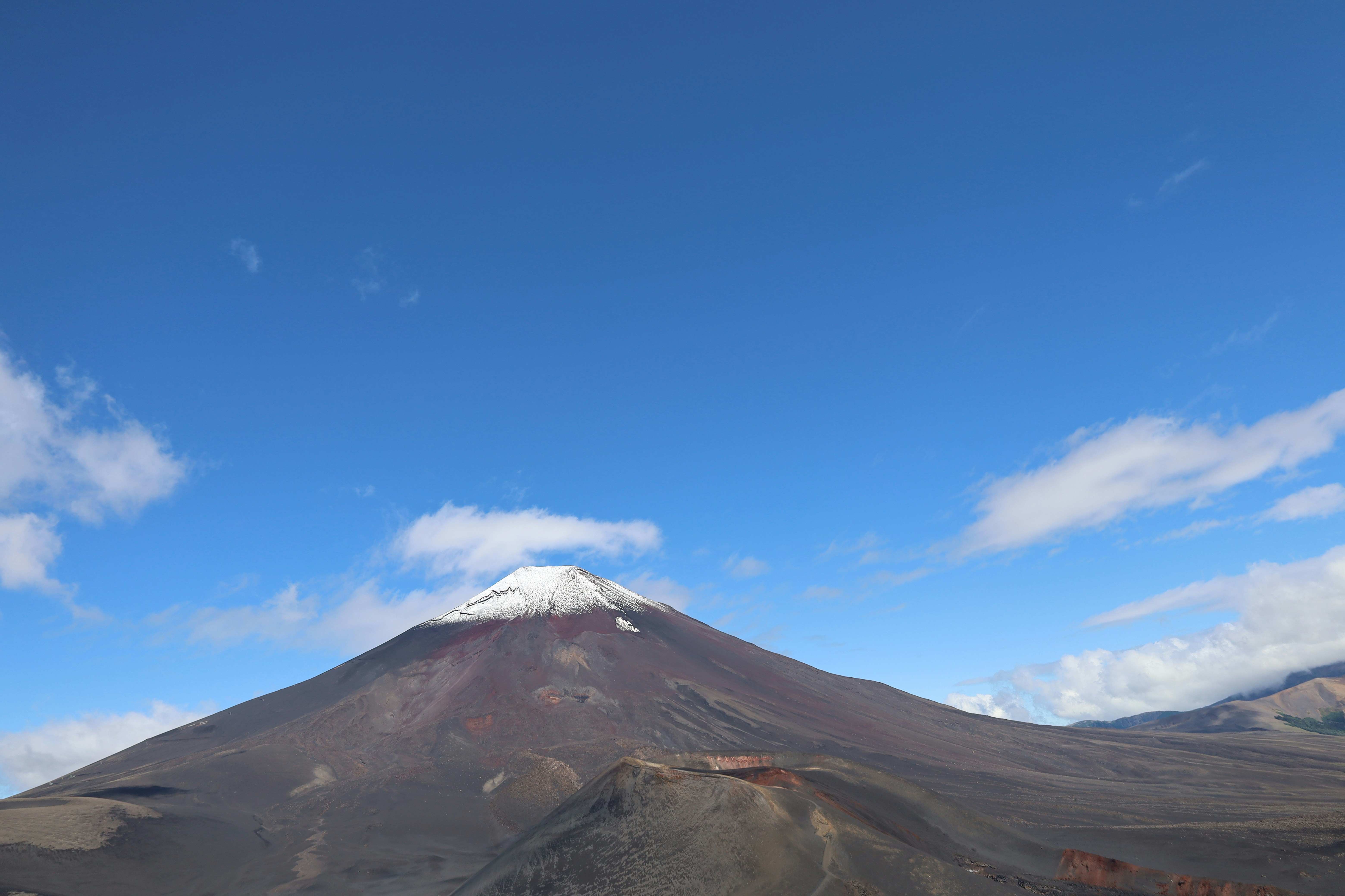 Snow-capped Peak Basking Under a Wide Blue Sky