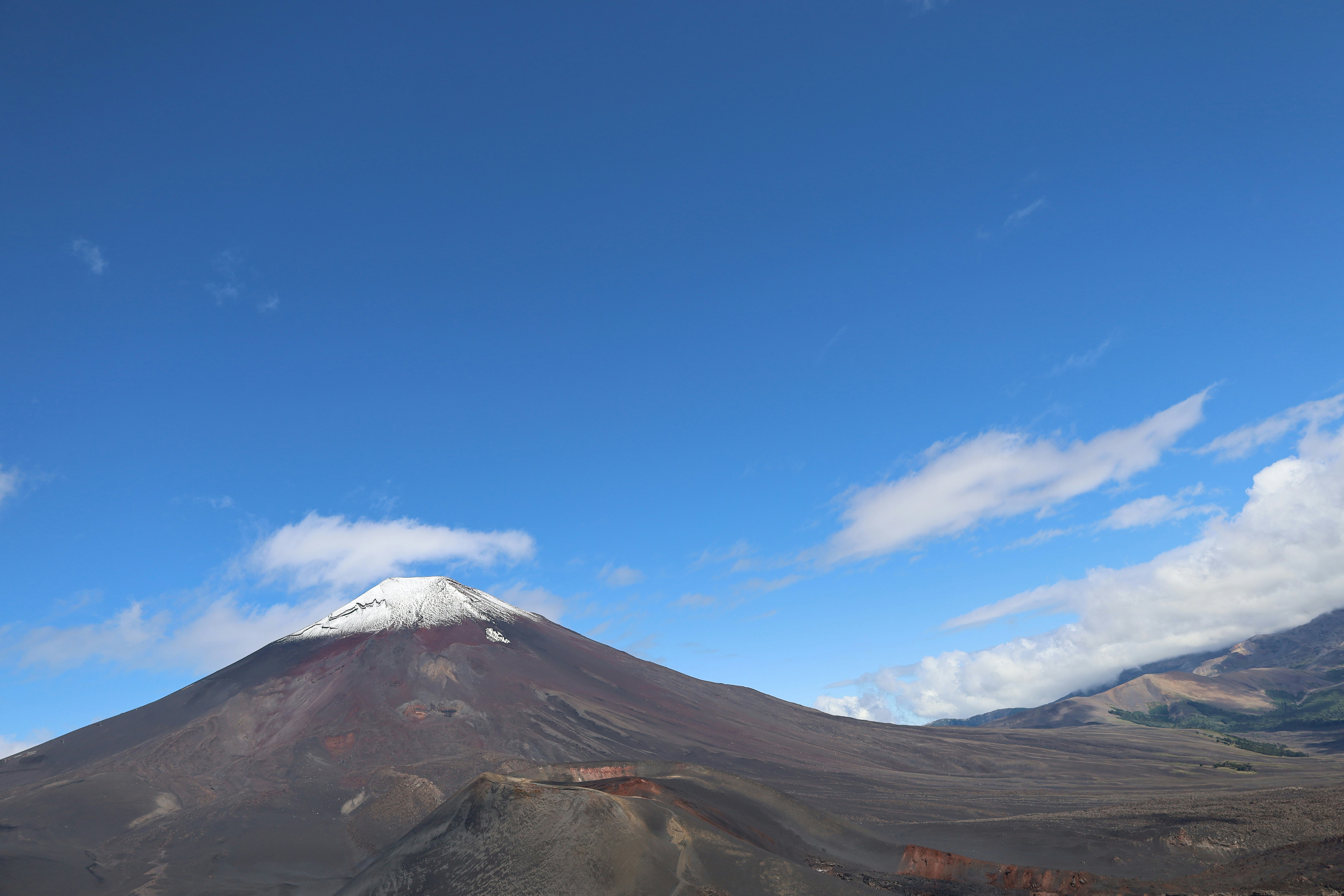 Snow-capped Volcanic Peak Under a Painted Sky