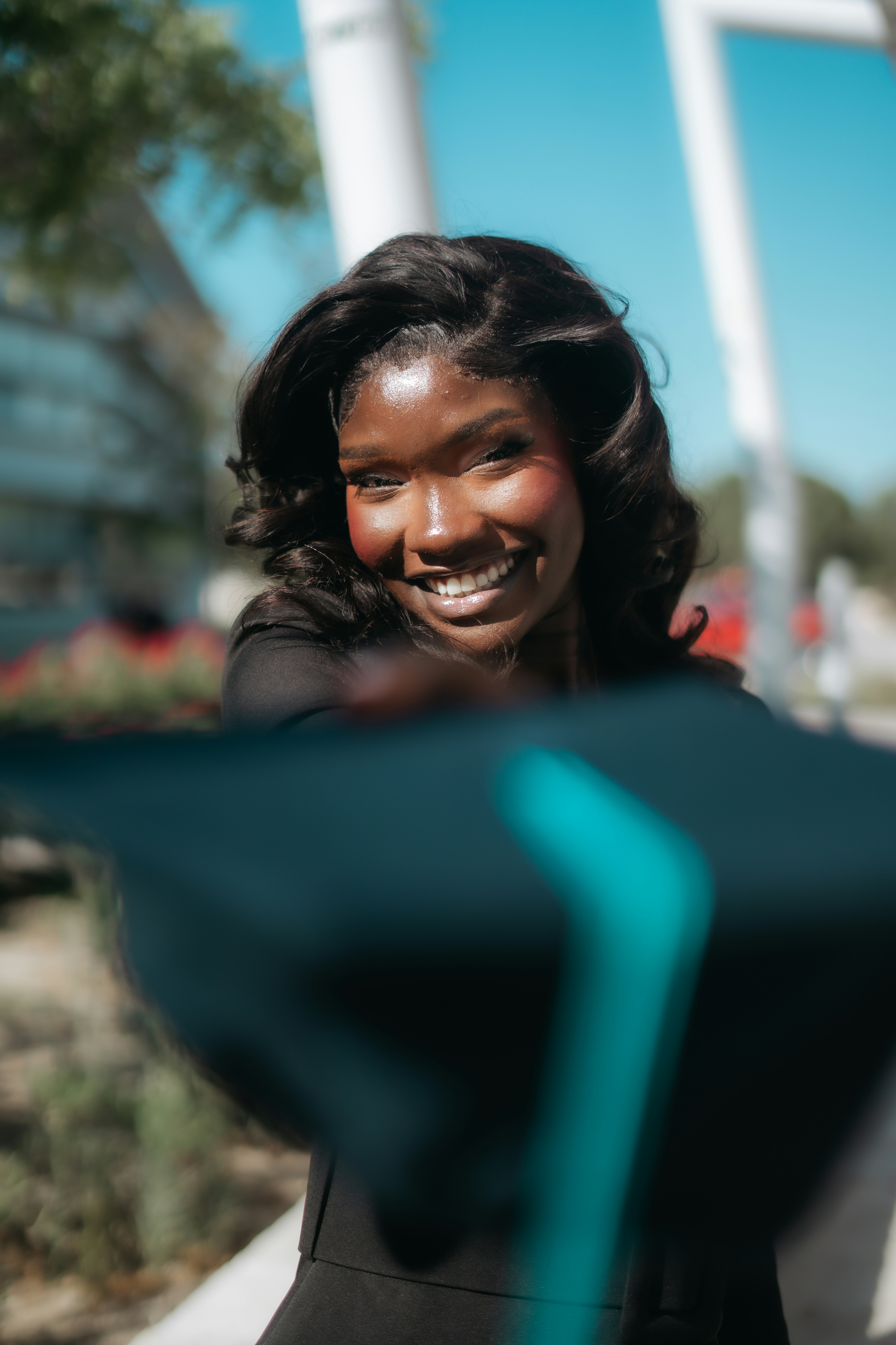 Smile in the Spotlight: A Confident Portrait at the Campus Gate