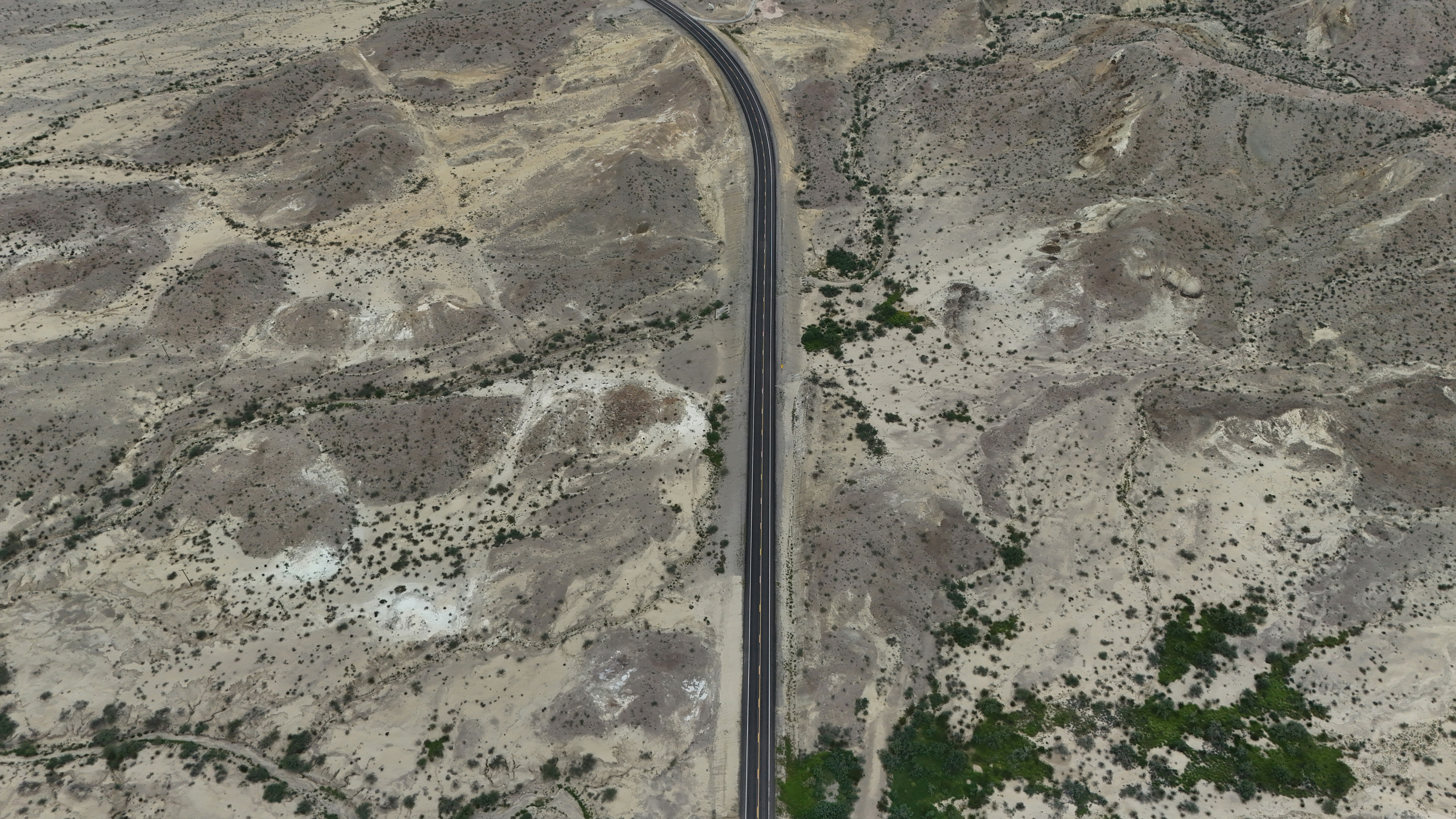 Desert Highway Slicing Through Arid Terrain