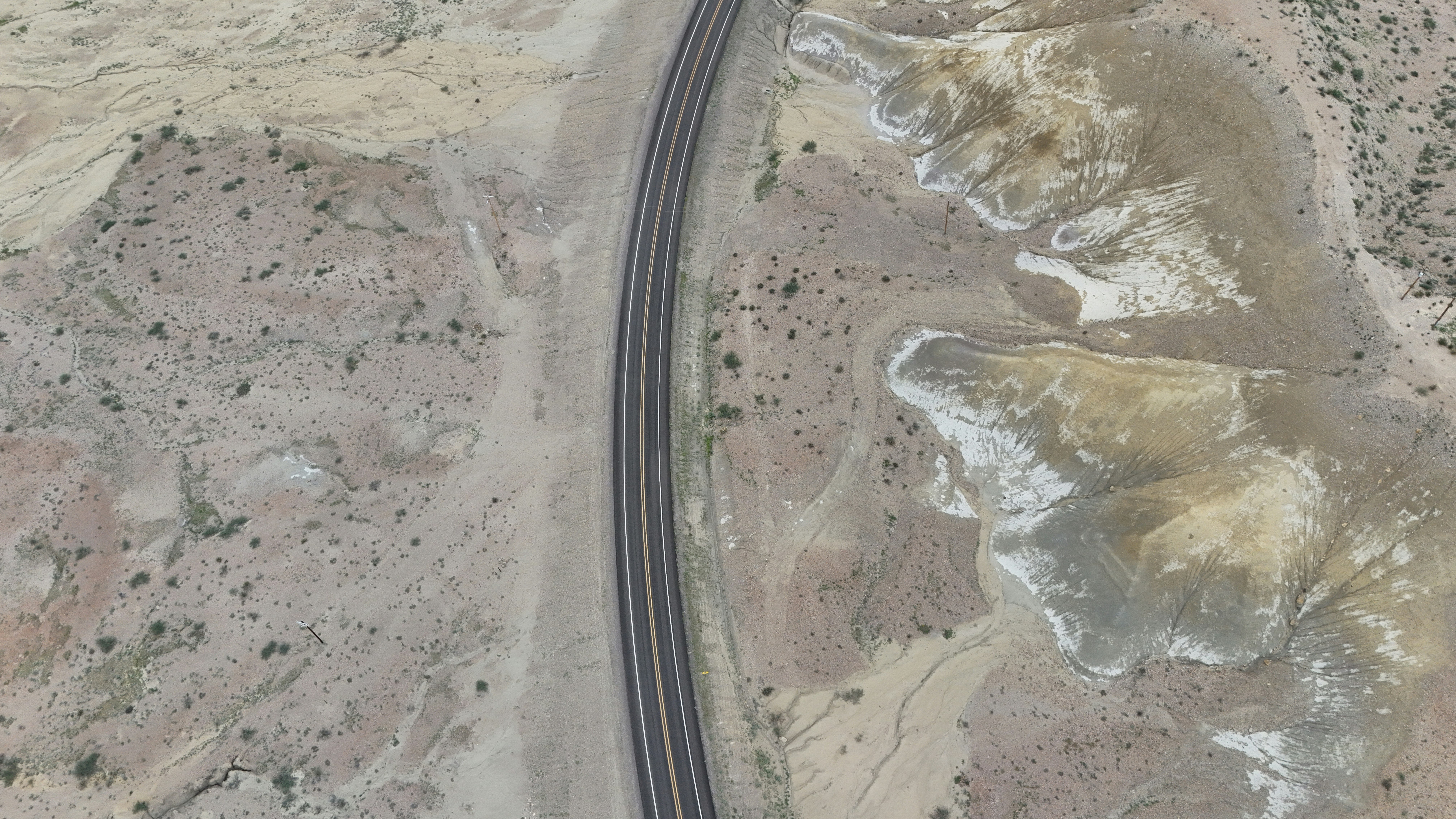 Curved Highway Divide: Aerial Arc Through Arid Terrain