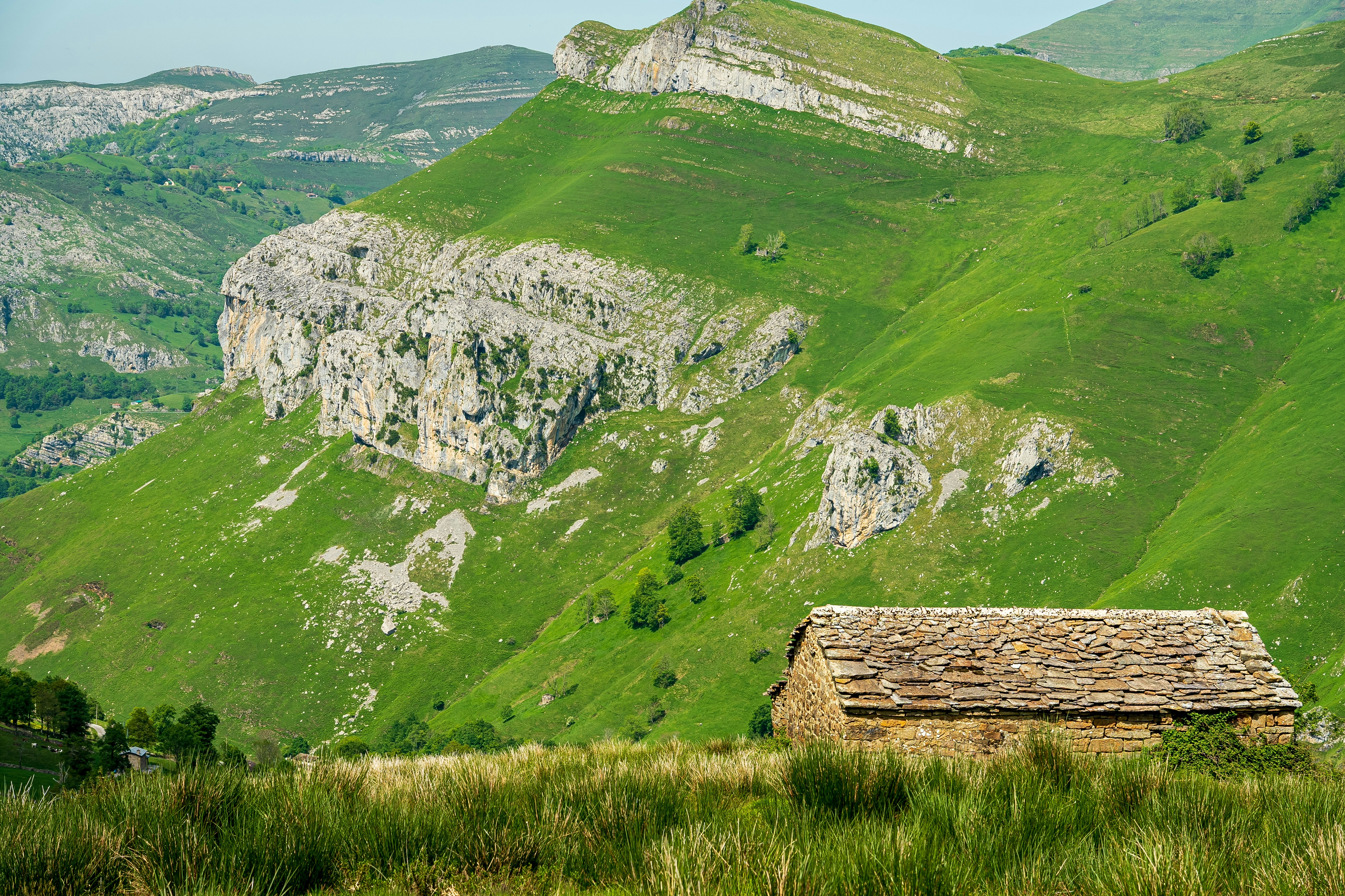 Green Slopes and Stone Shelter on a Mountain Meadow