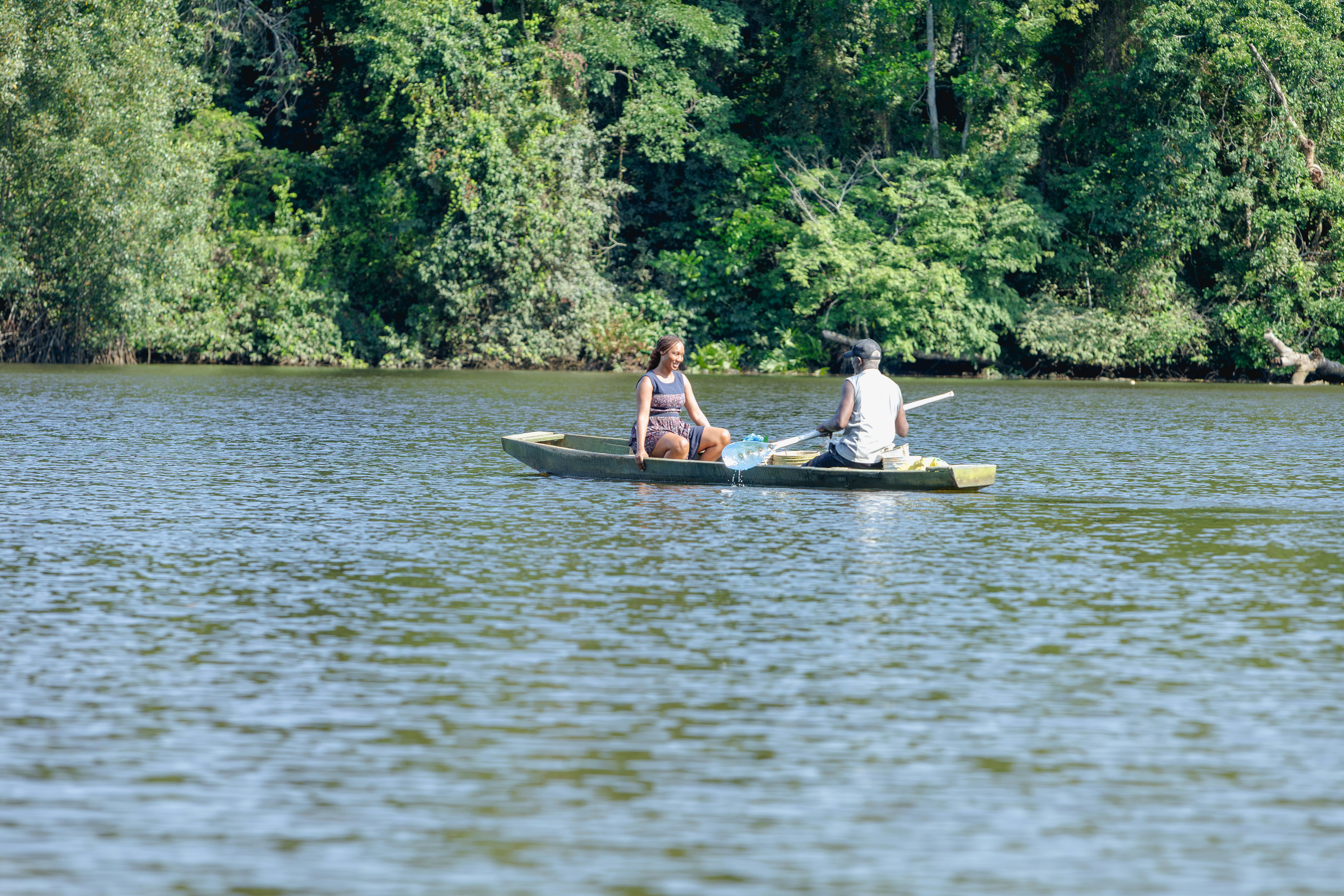 Two Kayakers Share a Quiet Moment on a Riverside Lake