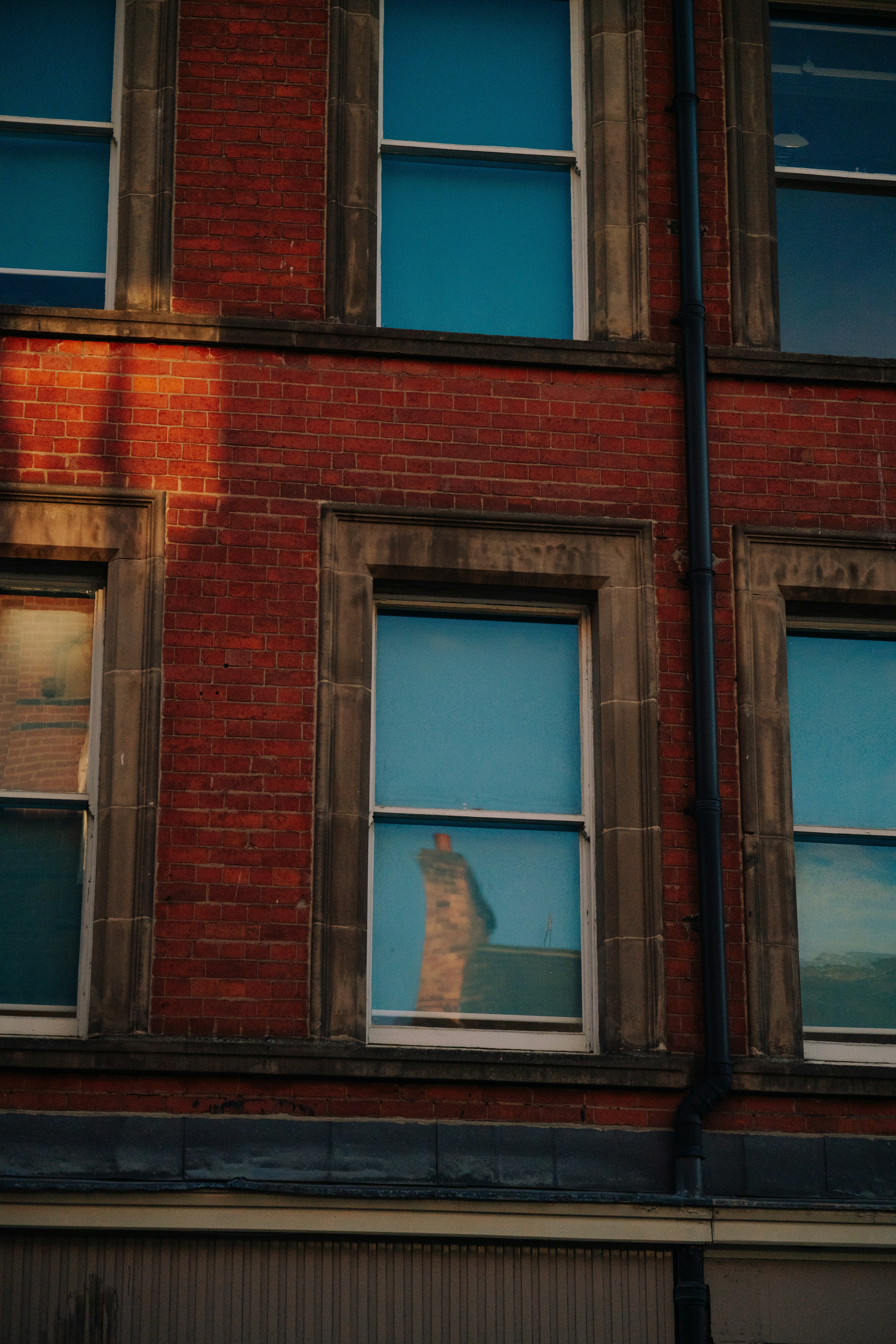 Brick Facade Echoes of Windows and Reflected Silhouette
