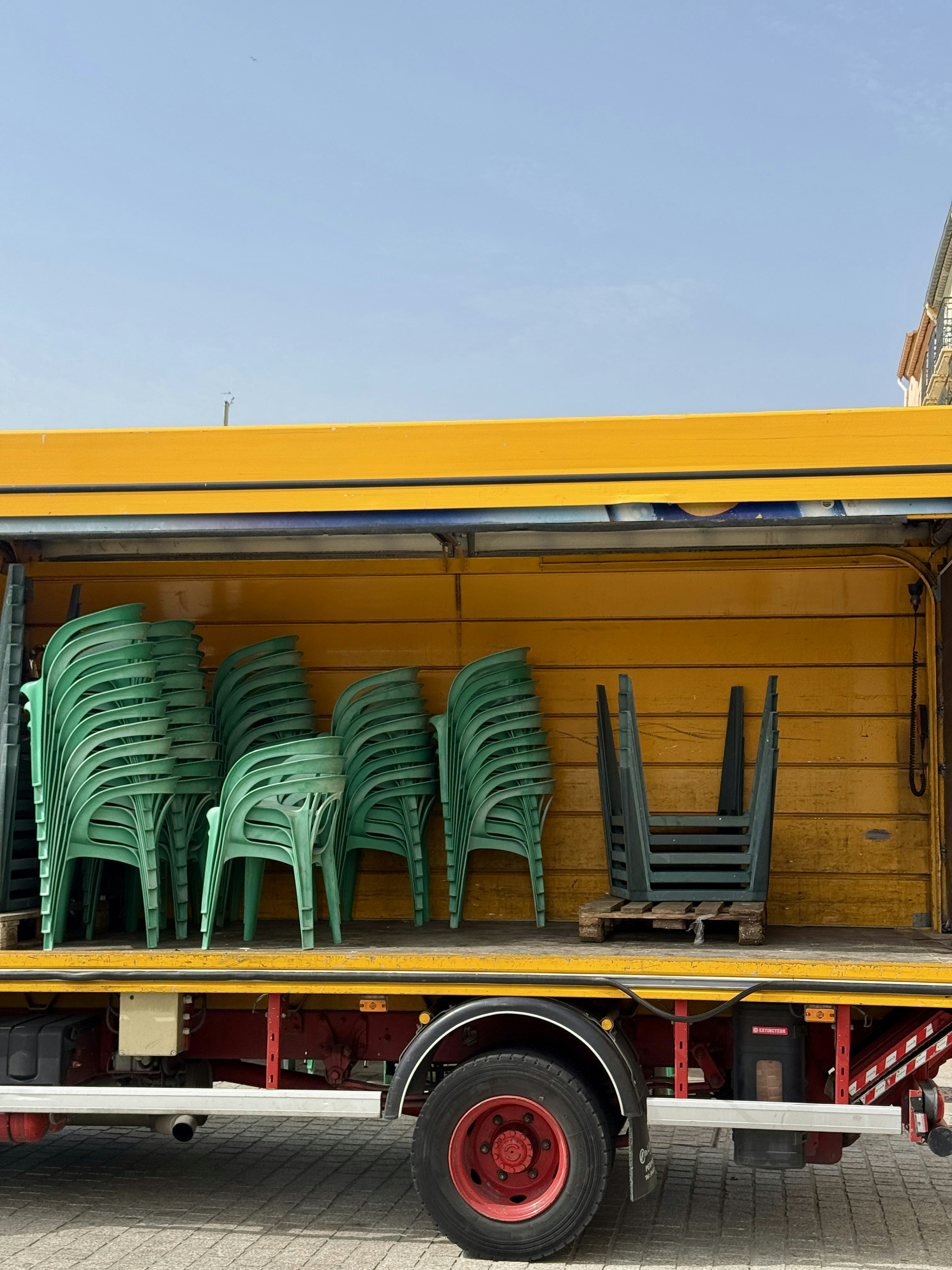 Stacked chairs and a yellow truck bed