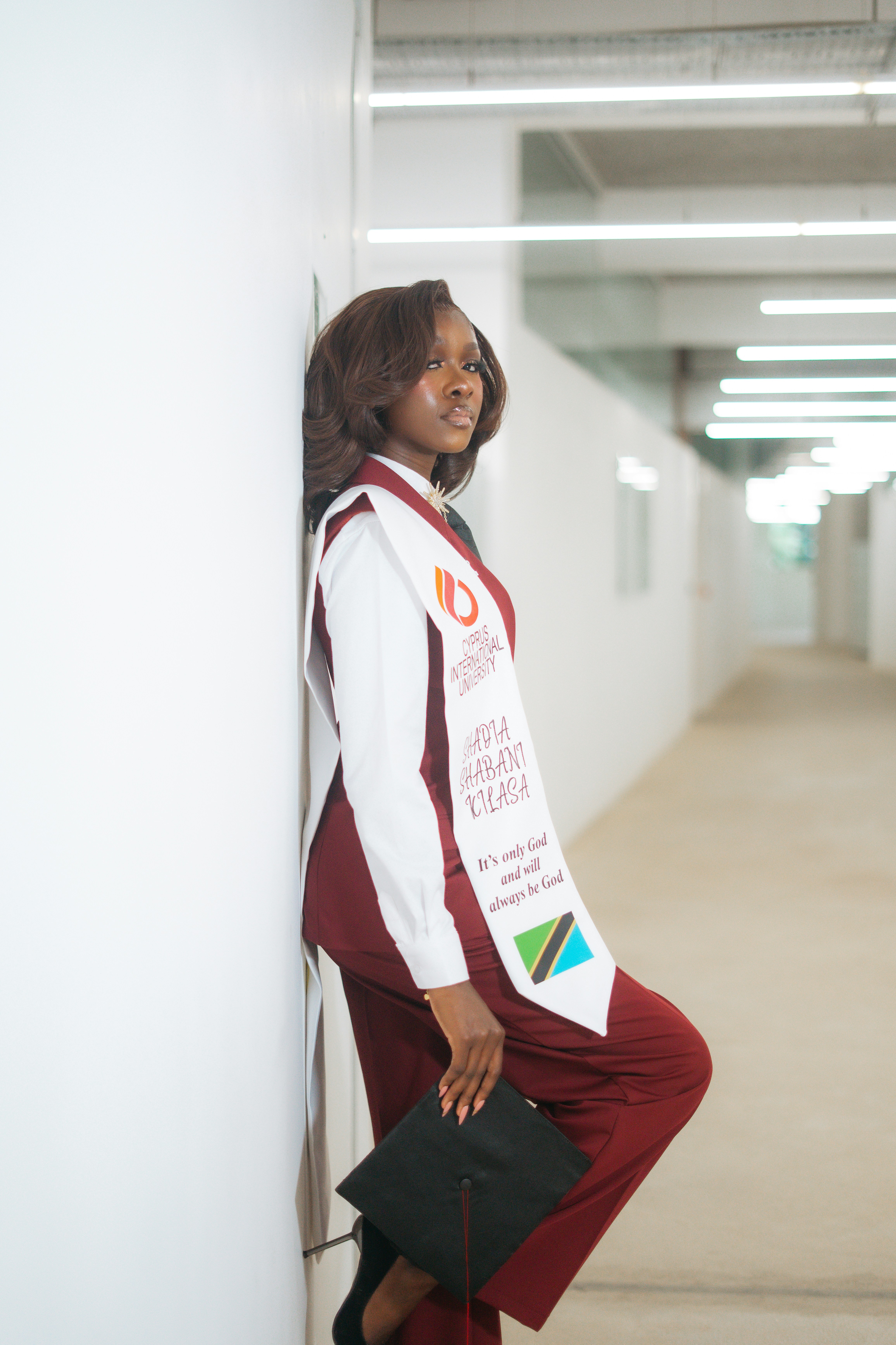 Graduation Portrait in a Bright Corridor