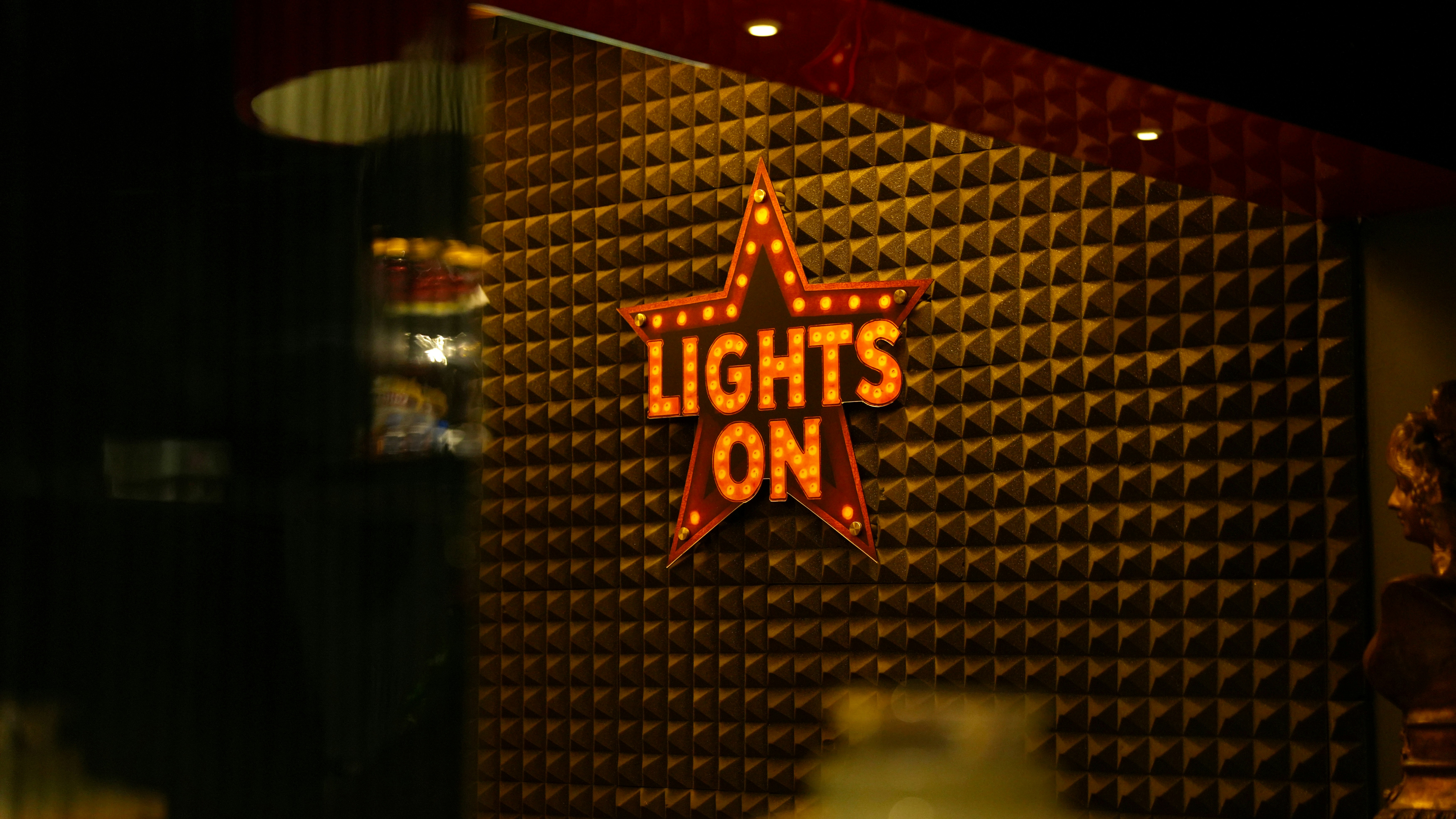 Neon Star Bursts Over a Quilted Wall