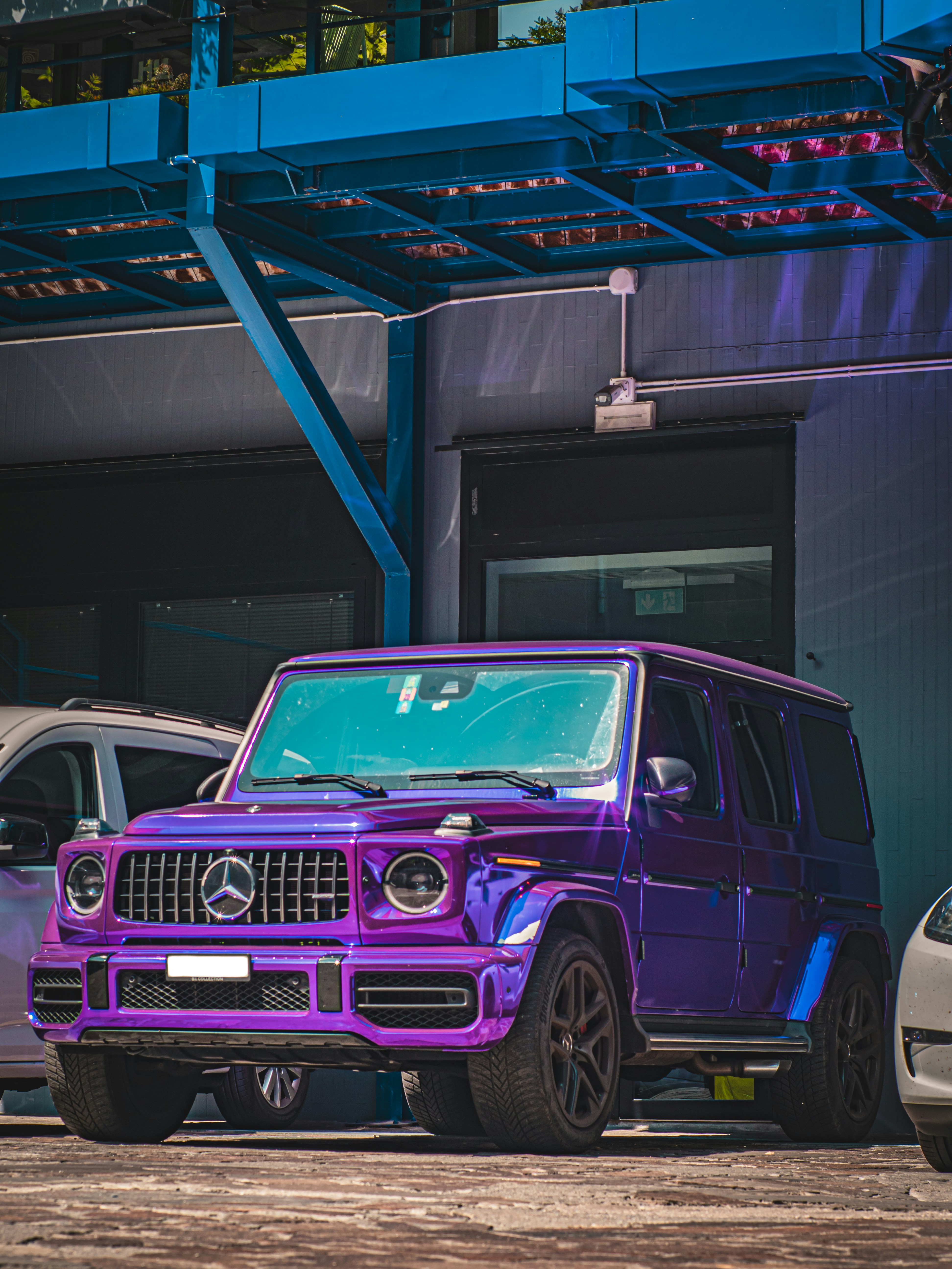 Vivid Mercedes G-Class in Electric Purple Under Urban Canopy