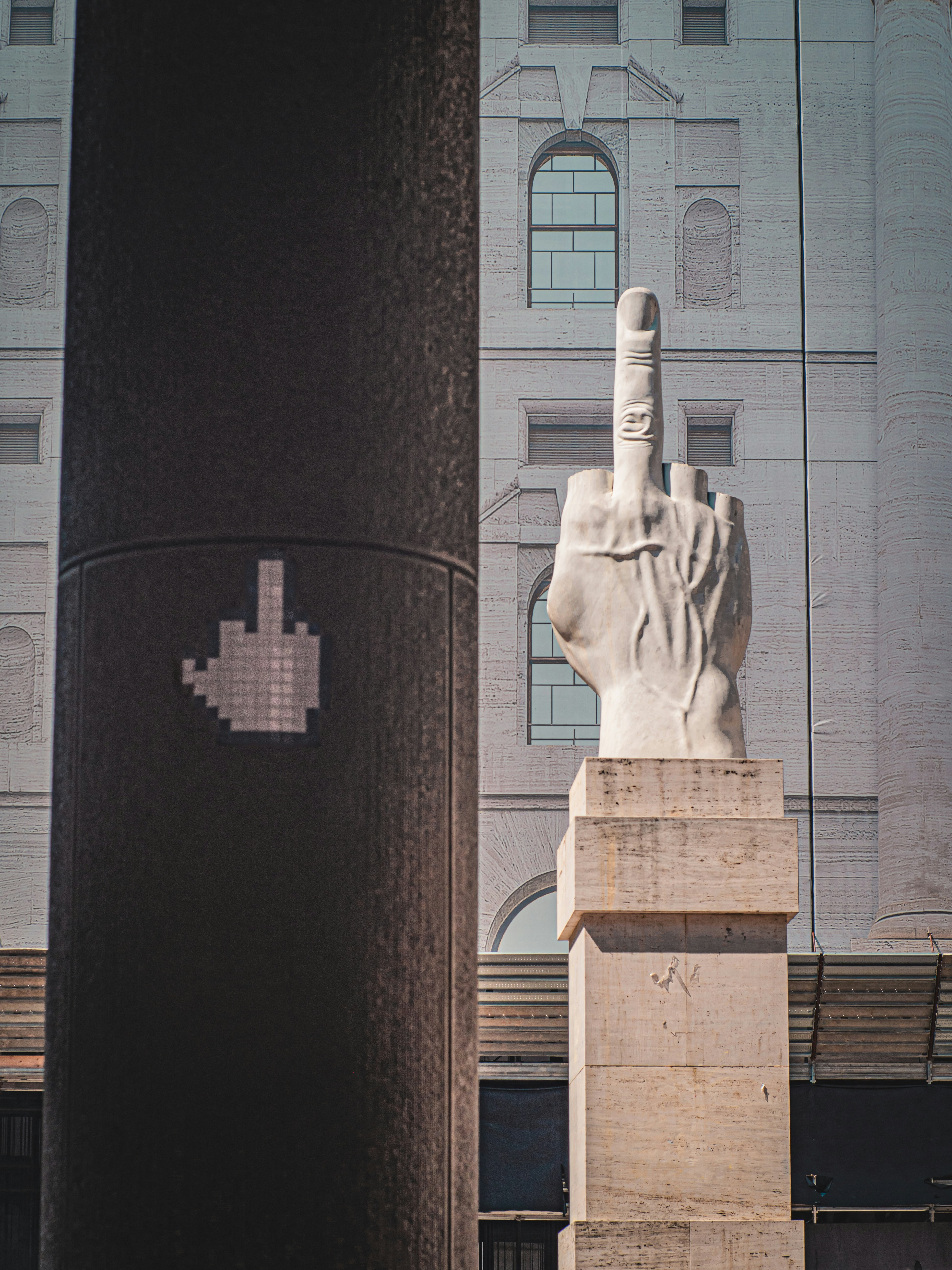 Midpoint of Defiance: A Stone Hand with Painted Pixel Gesture