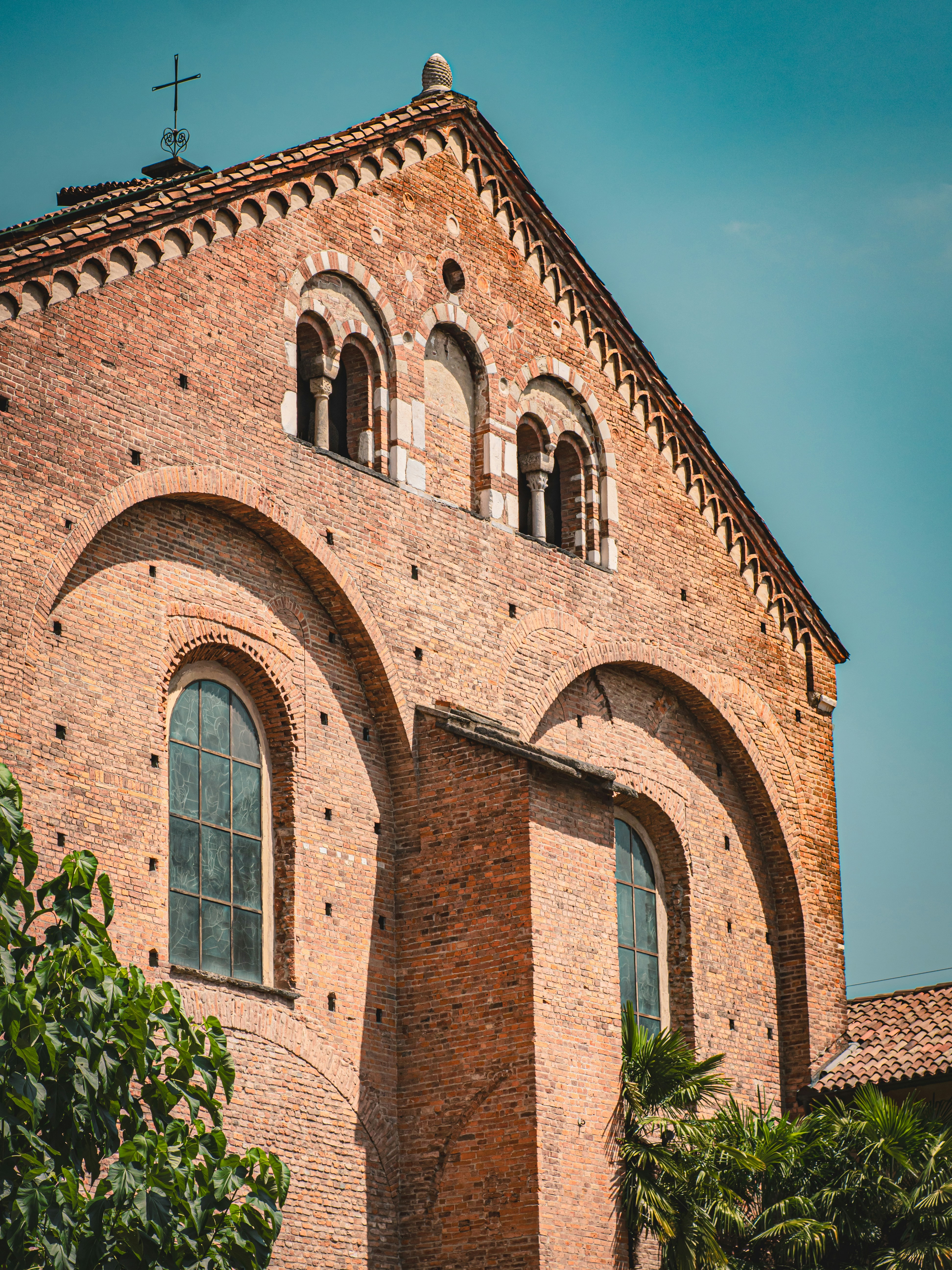 Brick Basilica: Arched Facade Reaching Toward a Clear Sky