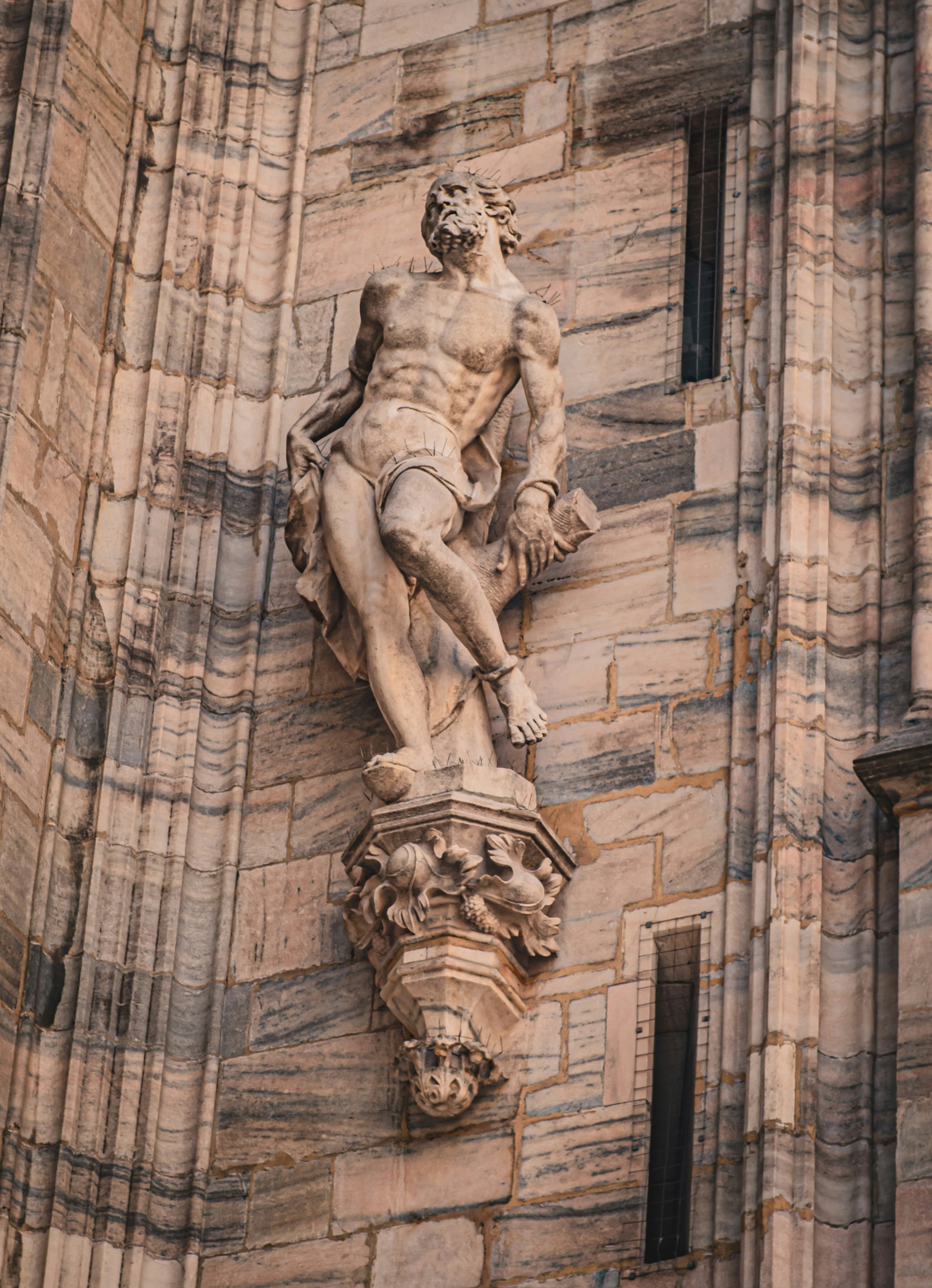 Stone Titan Crowned by Light: A Sculpted Figure Adrift on Carved Facade