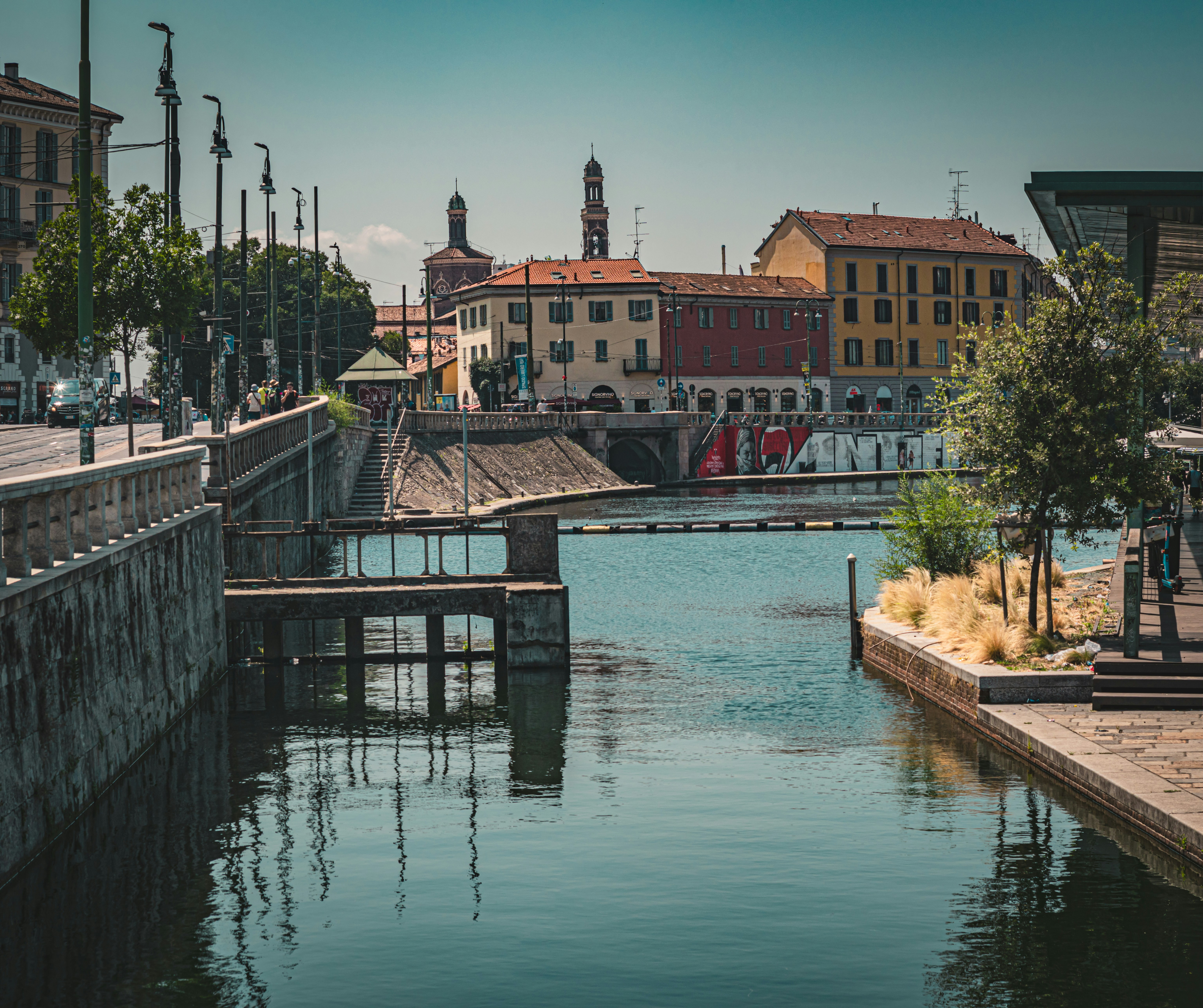 Riverside Clocktower Village: Sunset Over a Calm Italian Canal