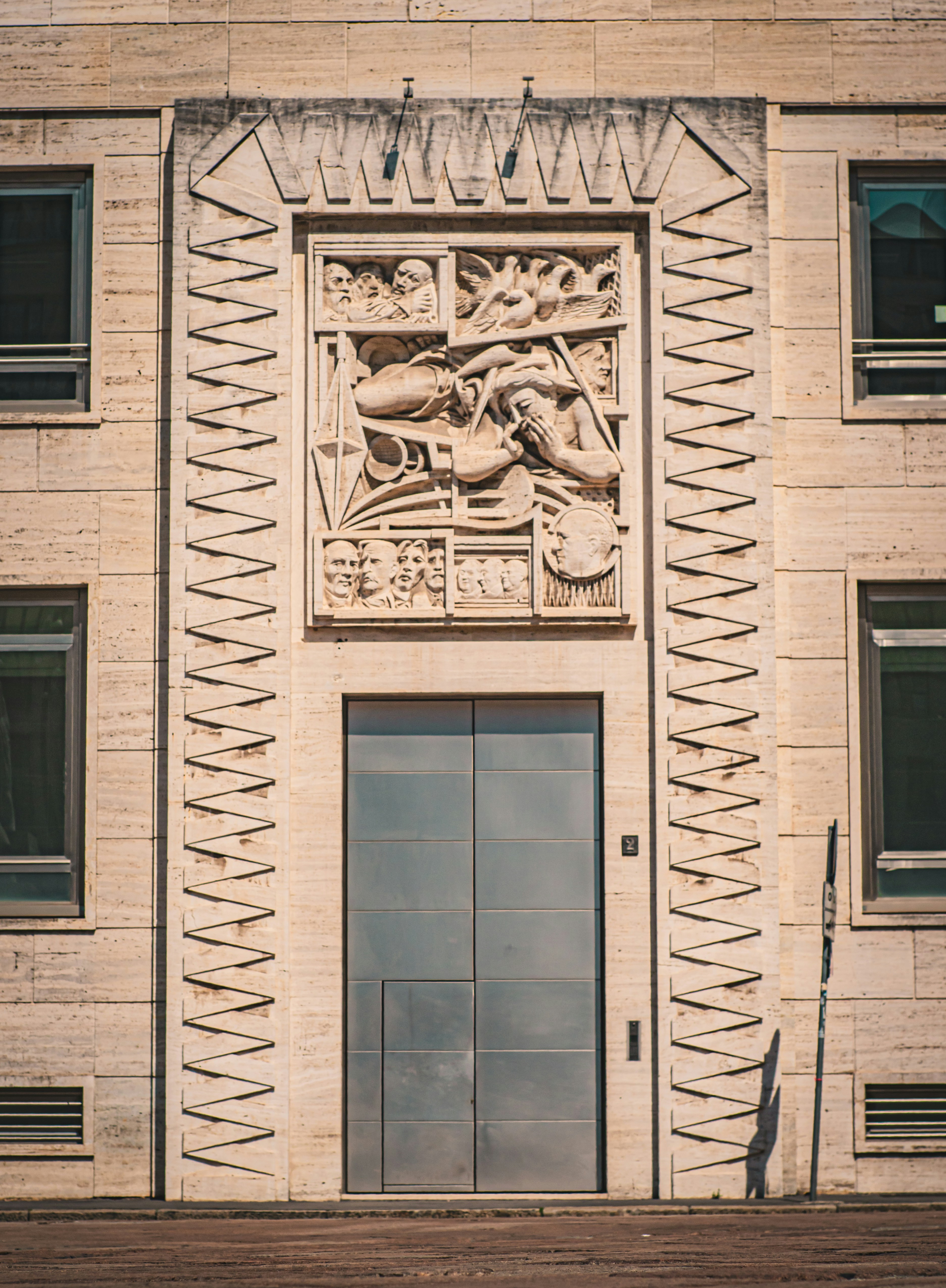 Carved Frieze Gate: Stone Sculpture Framing a Central Door