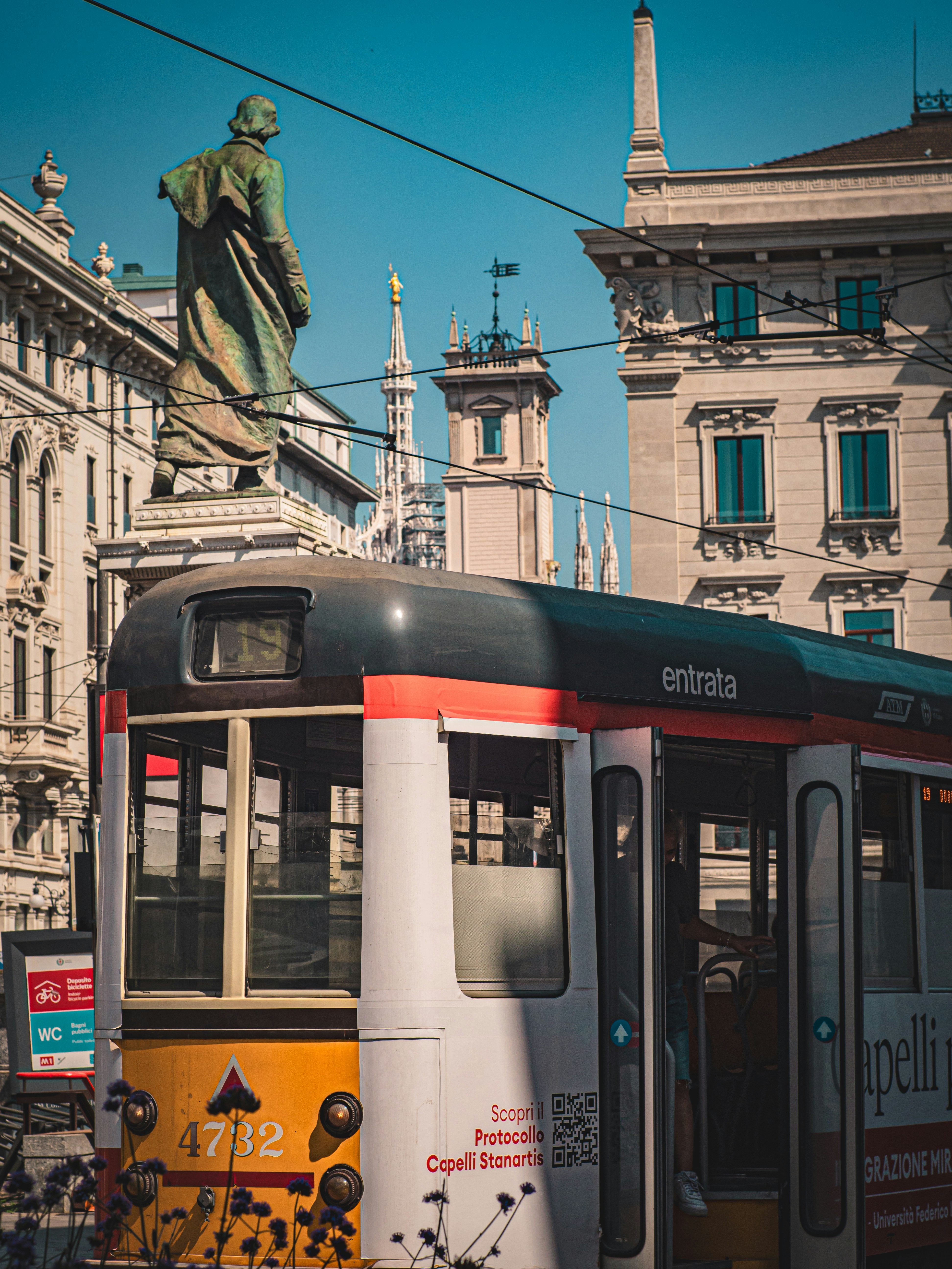 City Tram at Dusk: A Historic Square Framed by Statues and Architecture