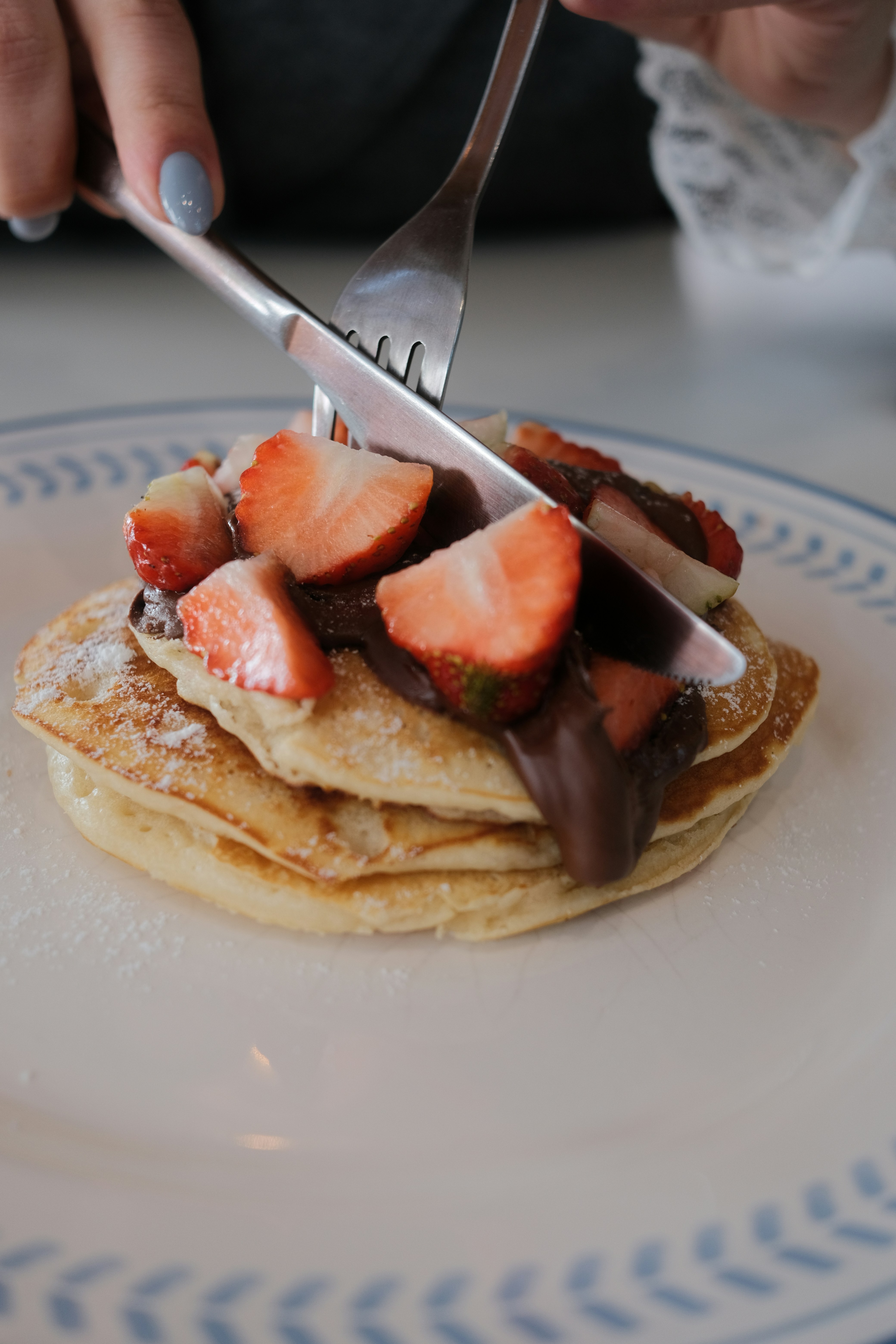 Stacked Pancakes with Chocolate Drizzle and Strawberry Crown