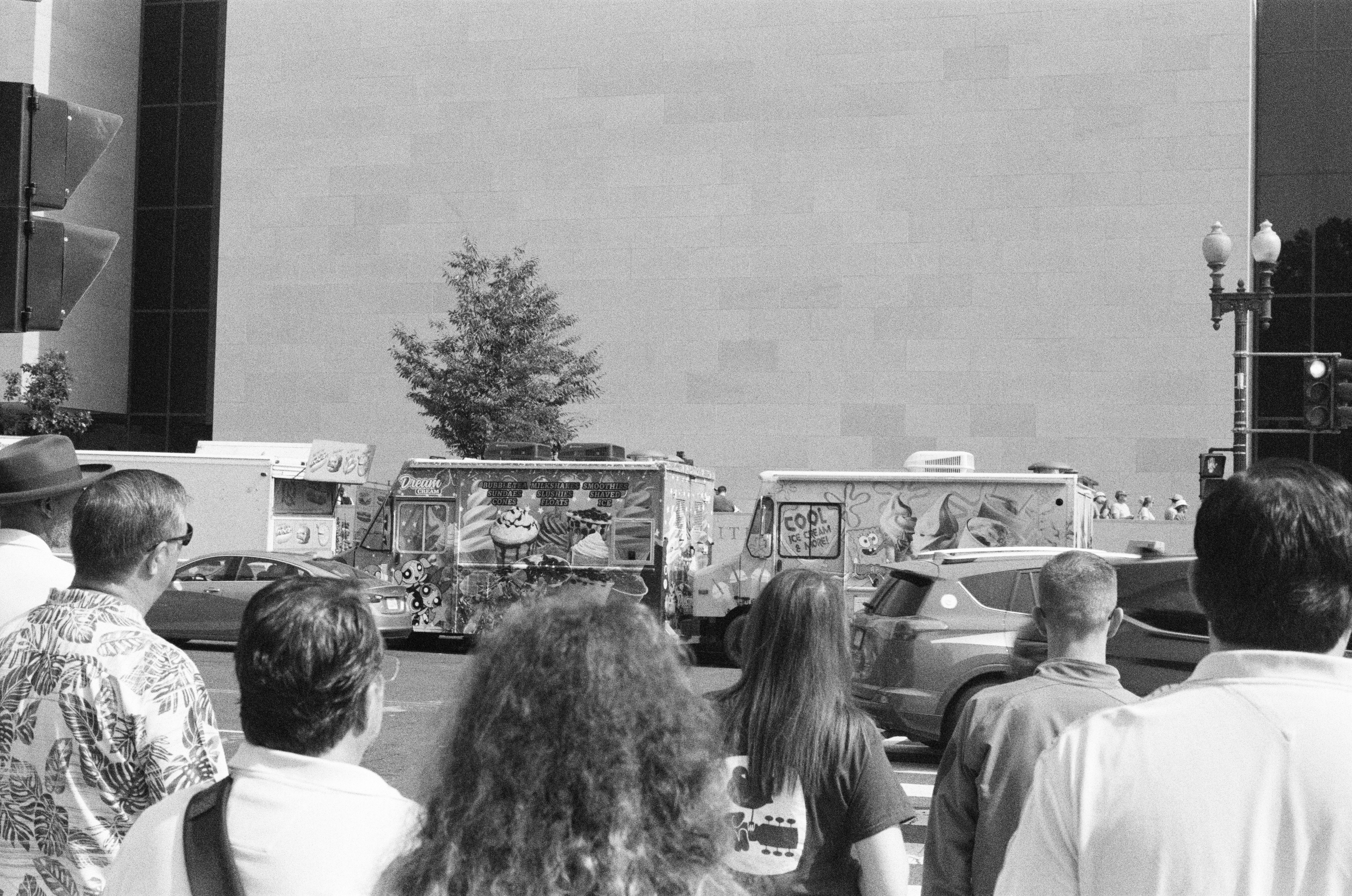 Behind the Street Parade: A Crowd Faces the Ice Cream Truck Row