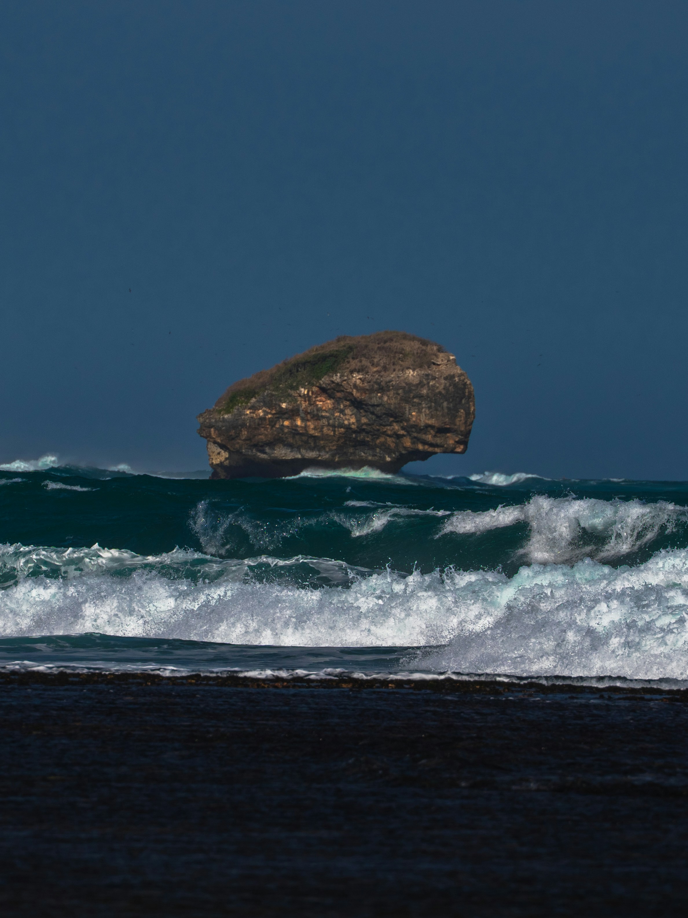 Isolated Sea Sentinel: The Lone Rock Stands Guard
