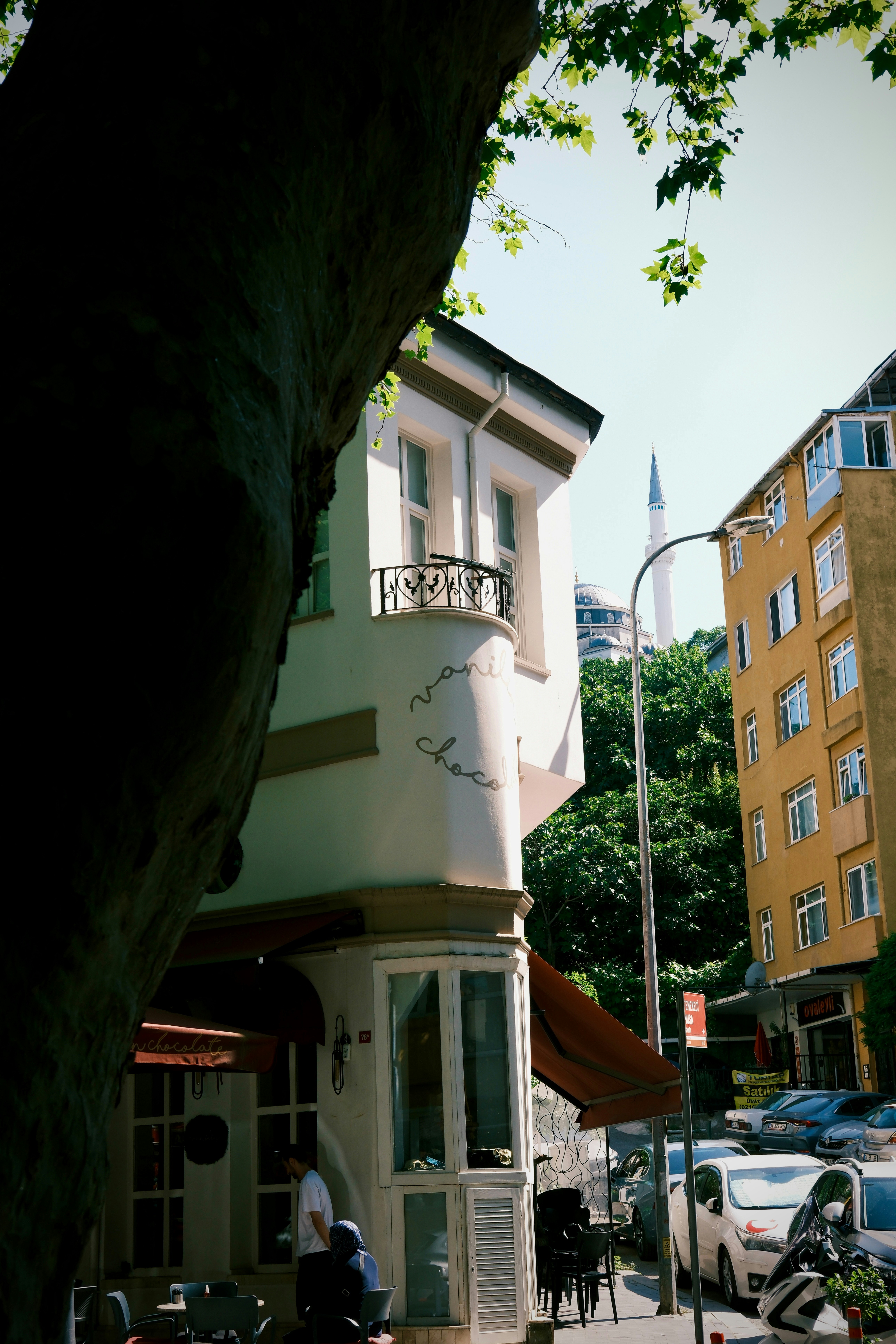 Sunlit Street Corner with Vintage Café Glow