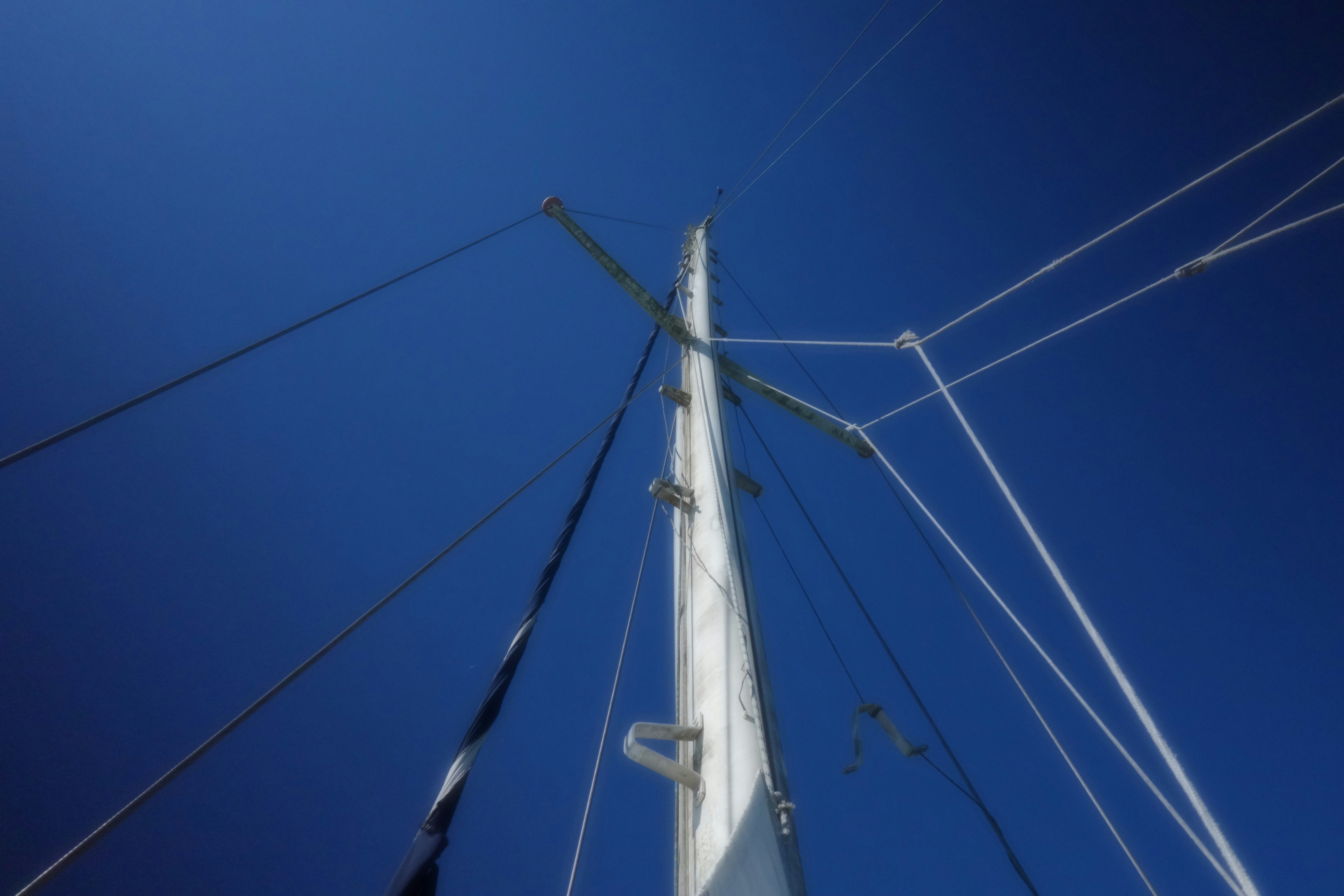 Mast and Cables Reaching Toward a Clear Blue Sky