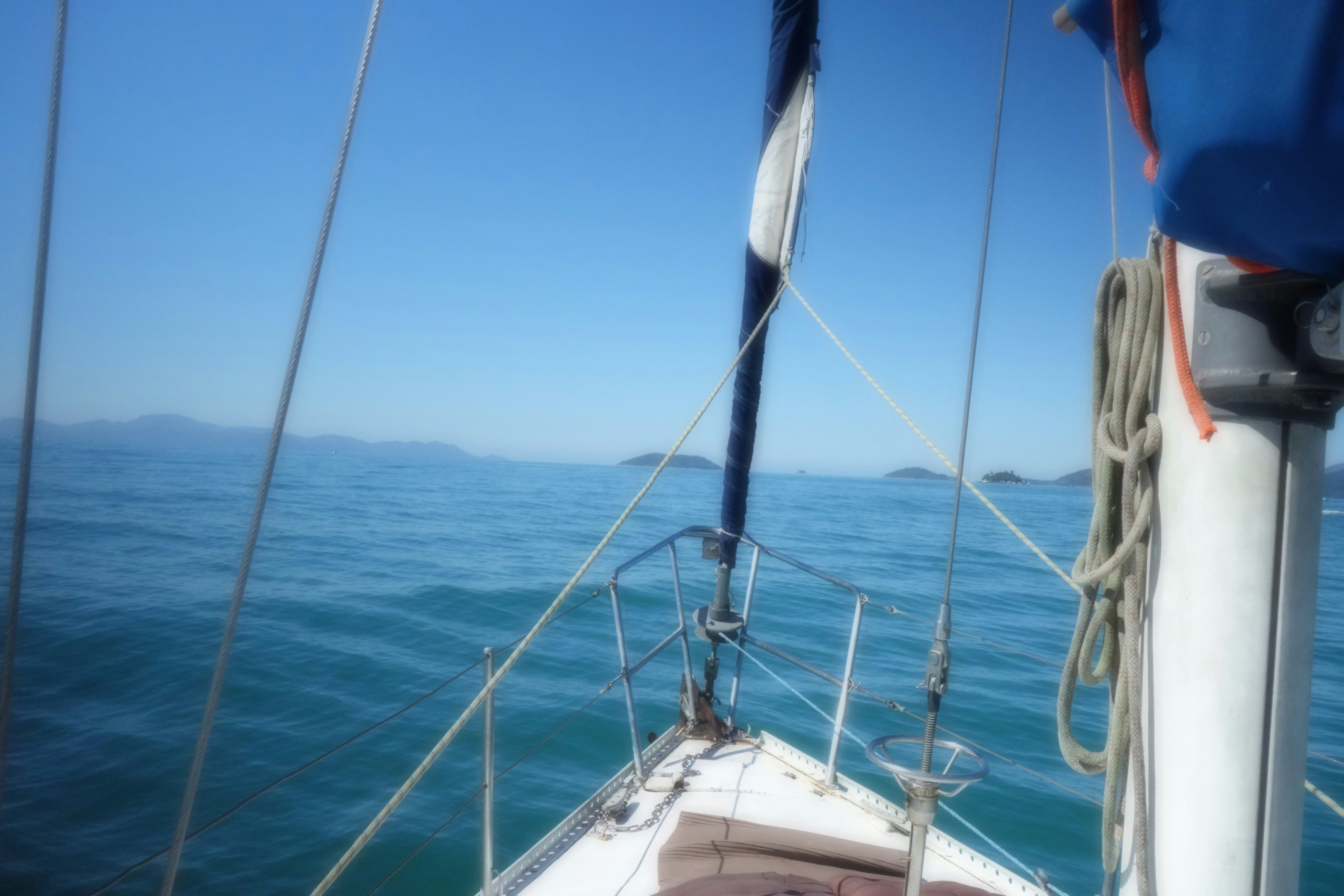 Bow of a Sailboat Slicing Blue Horizons at Calm Seas