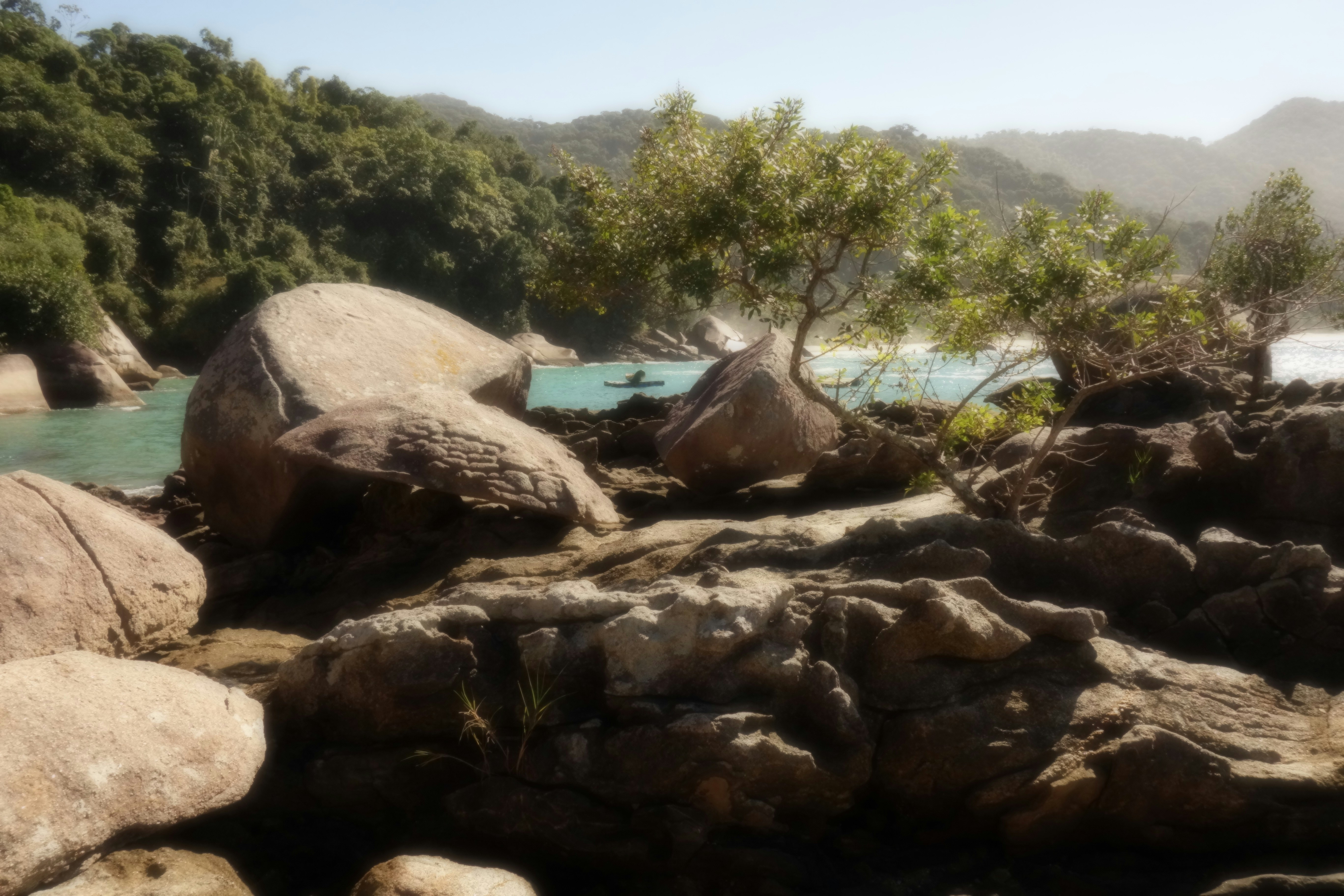 Quiet Cove Between Boulders: A Sunlit Shore in Stone