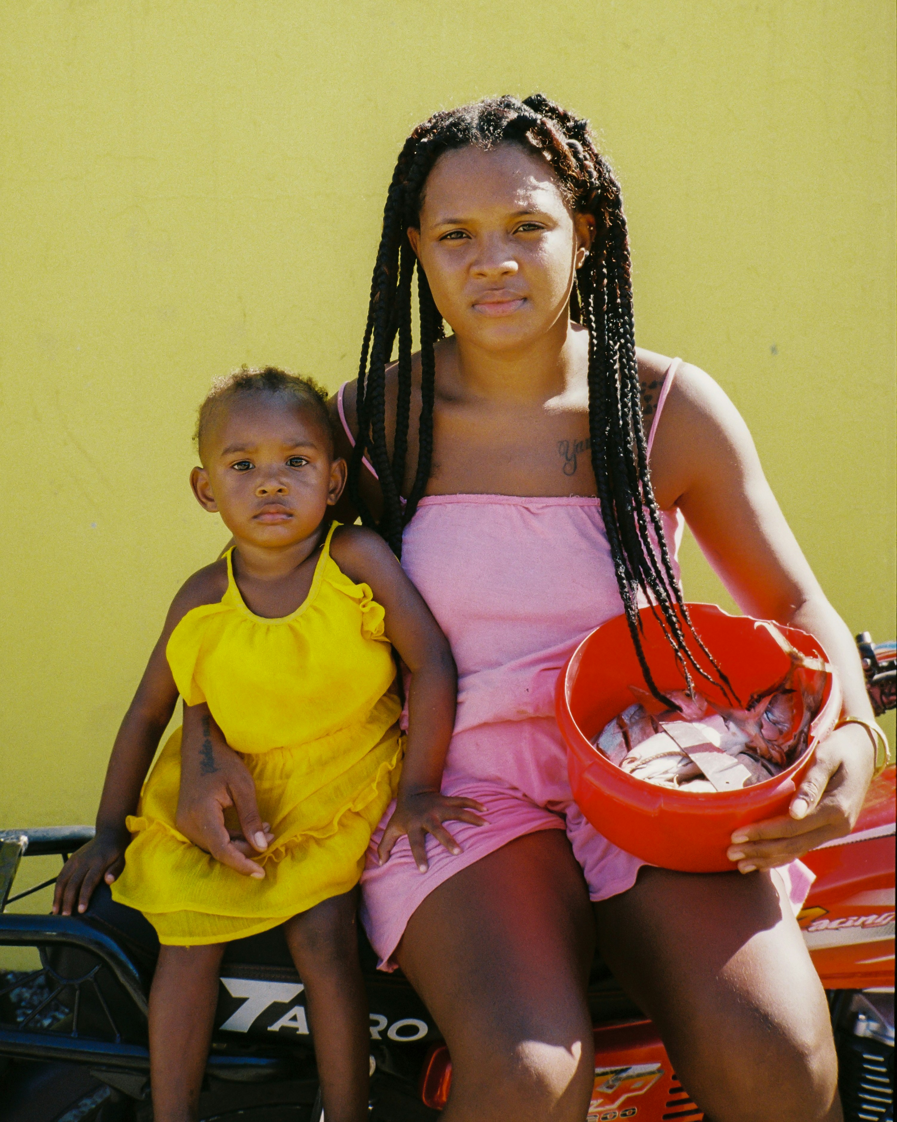 Mother and Child Silhouette in Bright Yellow and Pink on a Yellow Backdrop