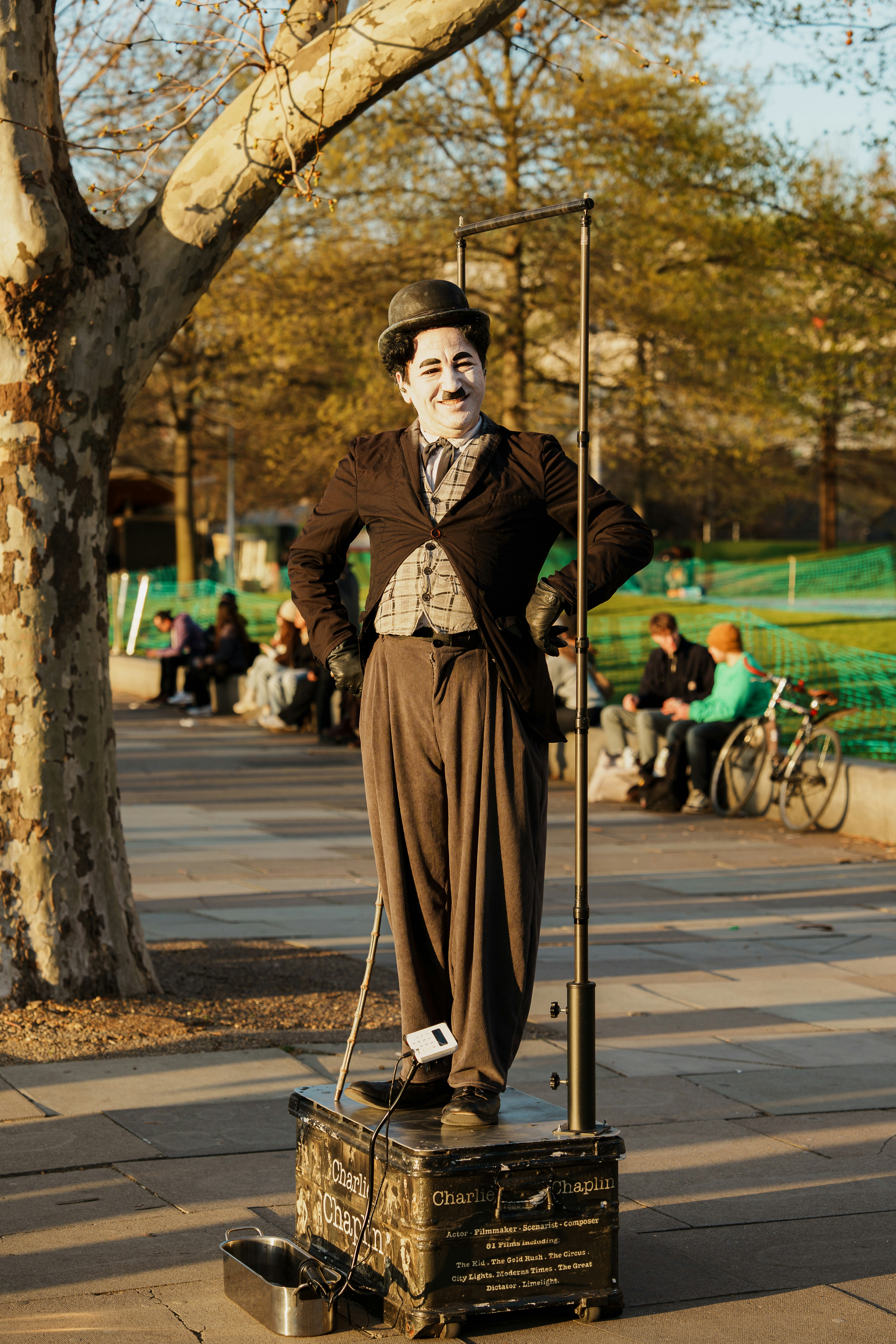 Street Performer in Vintage Attire Stands Confident on a Hand-Cart Platform