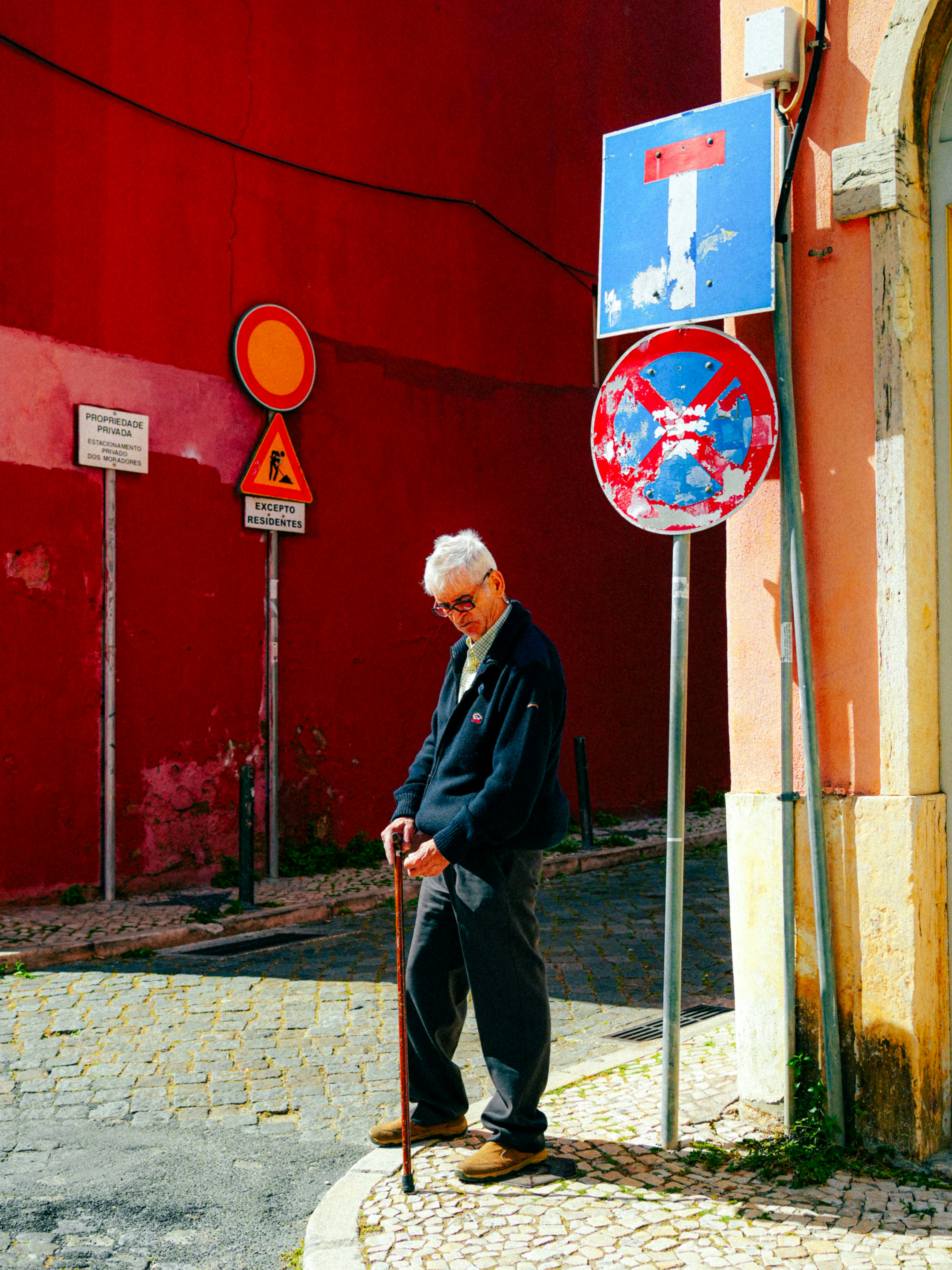 Old Steps, Red Walls: A Wise Wanderer with a Walking Stick