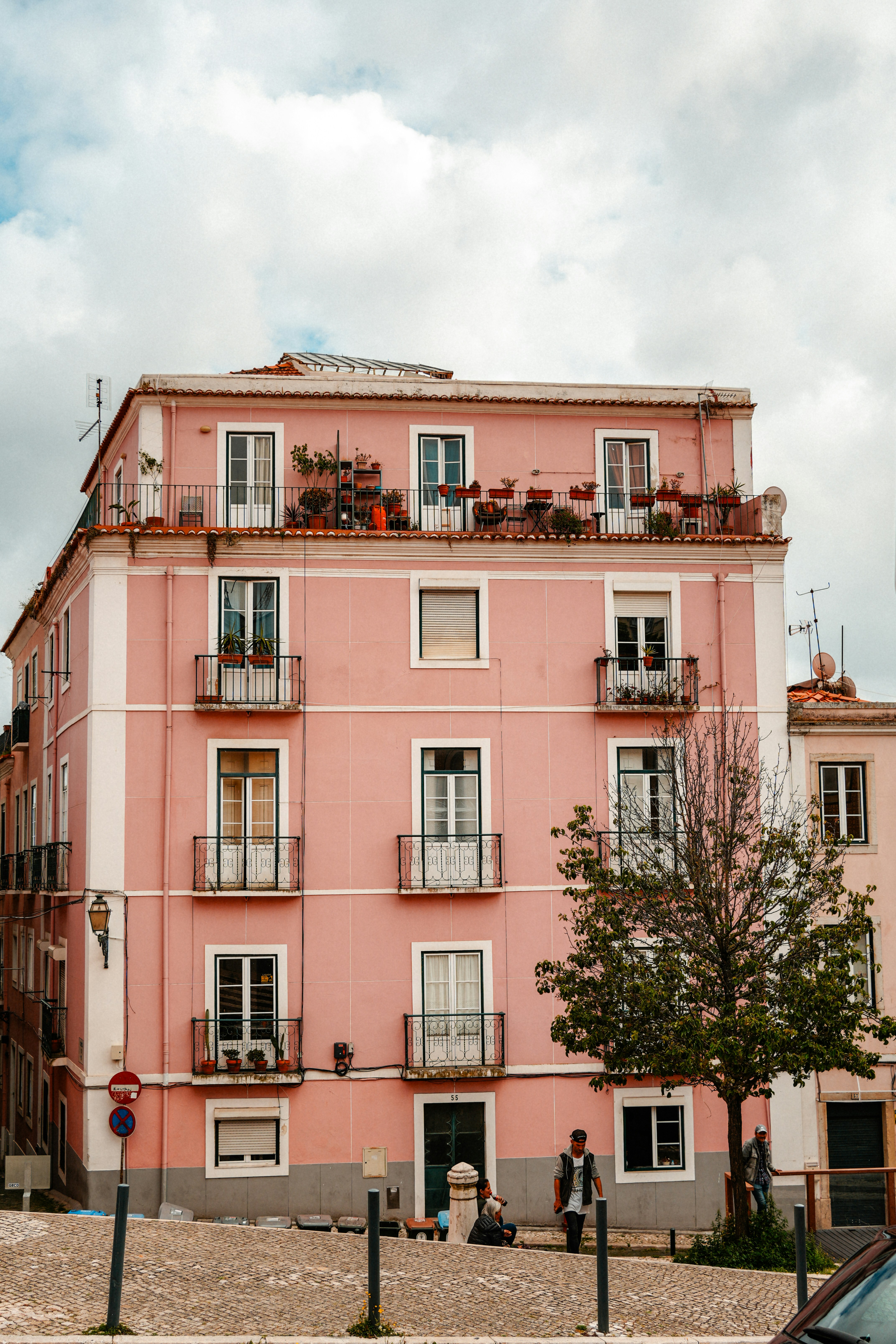 Pink Facade, Quiet Street: A European Apartment Row in Soft Evening Light
