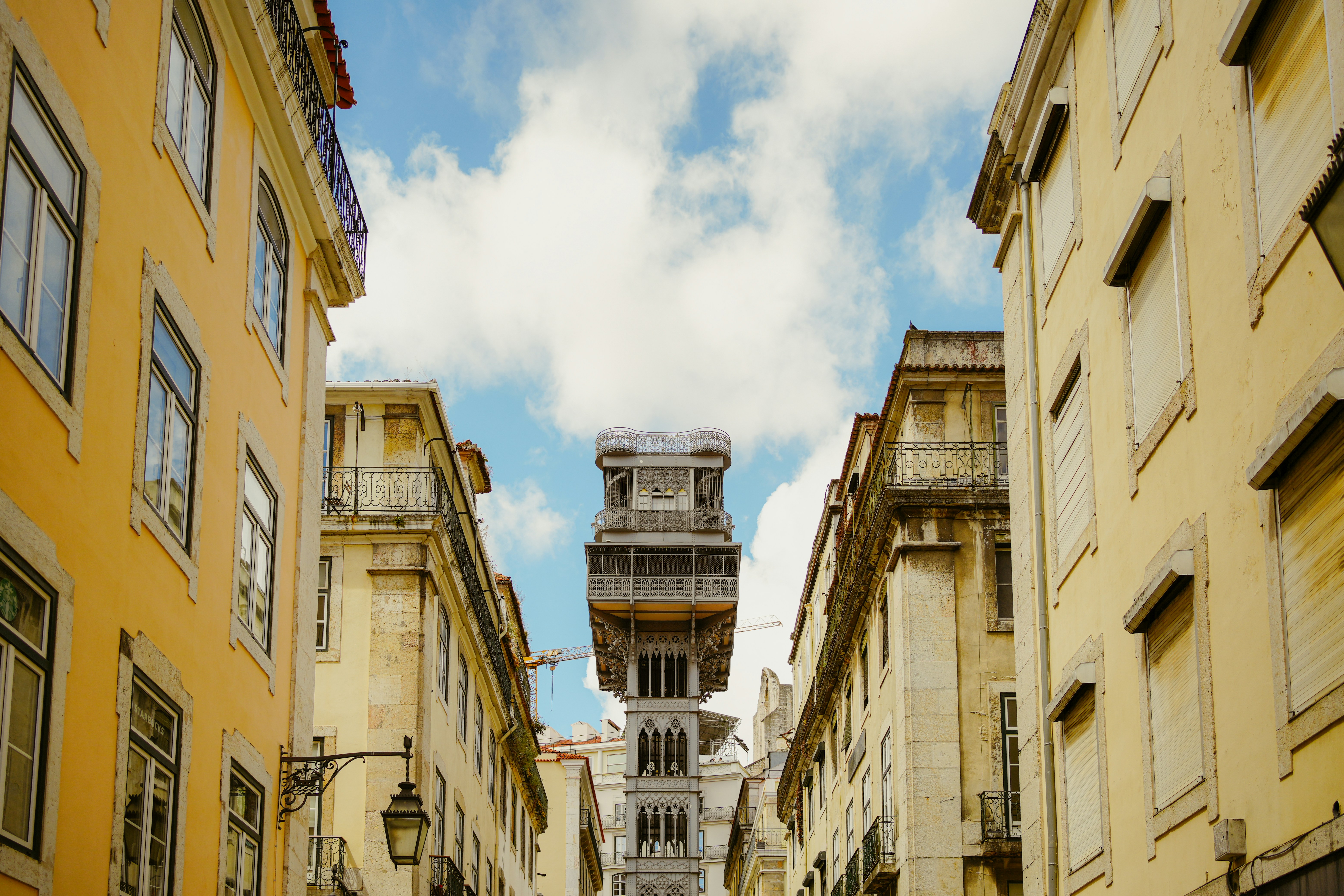 Towering Clockscape: A Narrow Street Reaches for the Sky