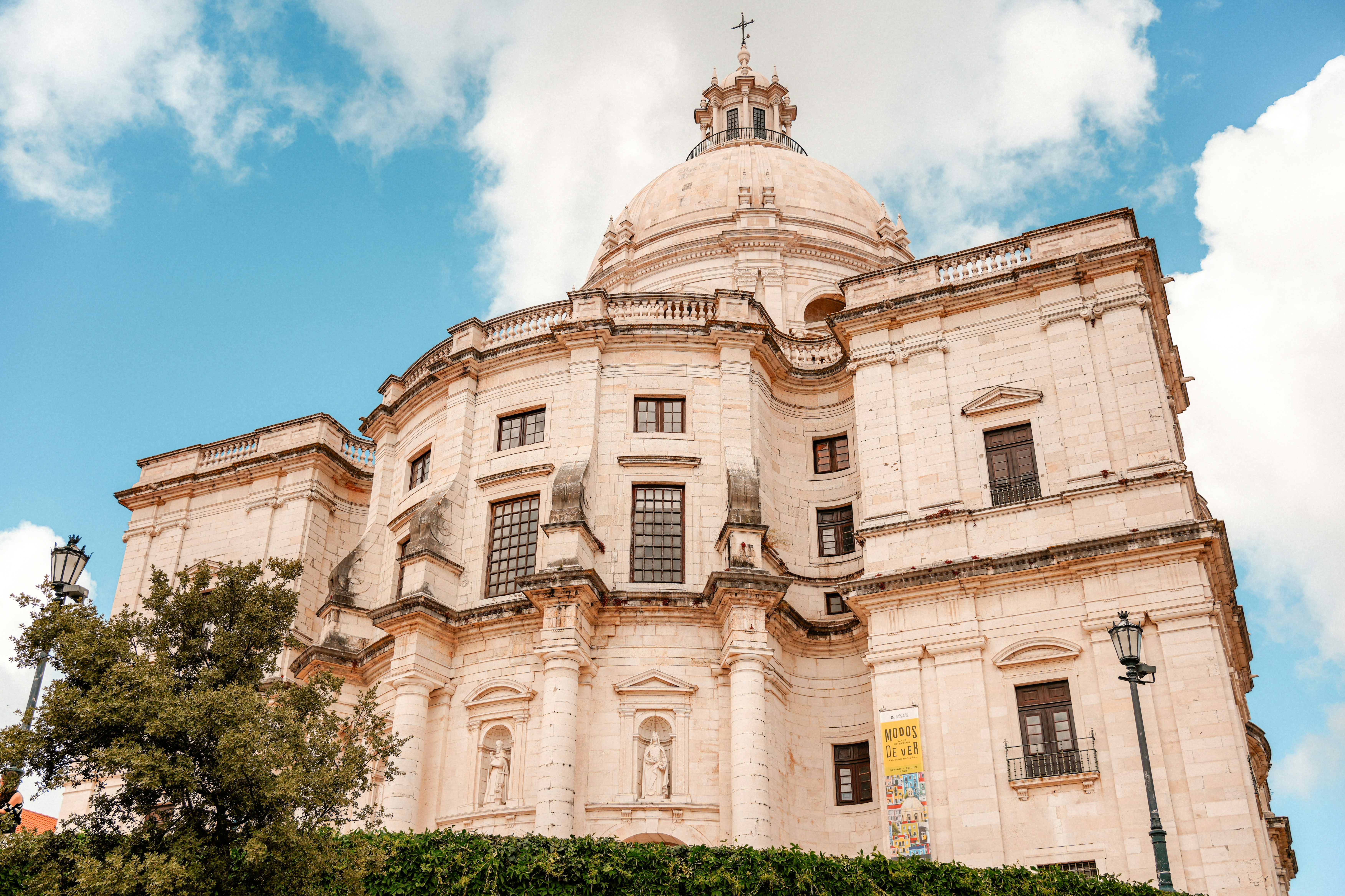 Baroque Cathedral Face: Sunlit Marble and Dome Under a Bright Sky