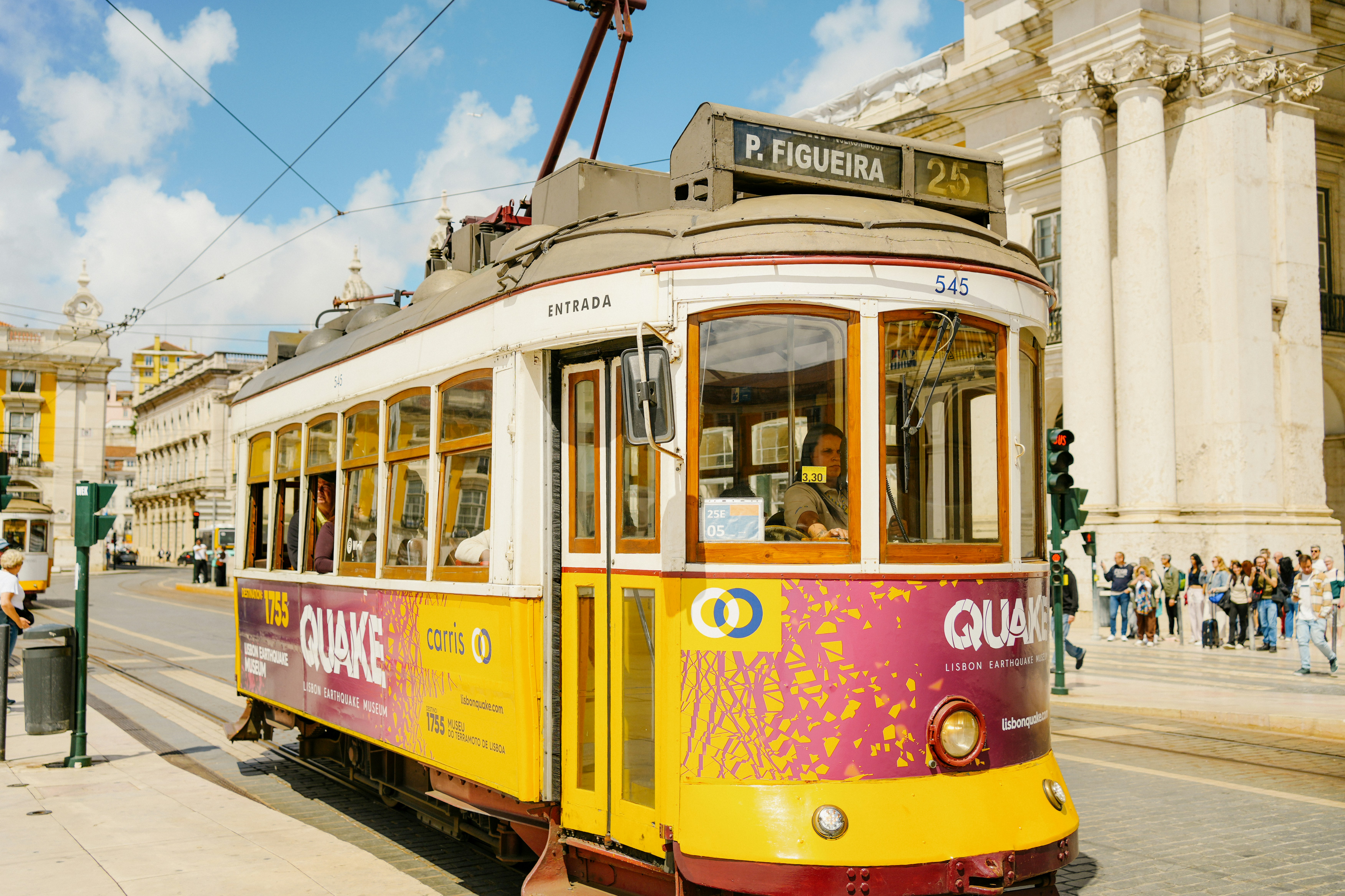 Bright Yellow Tram Rounds a Historic City Corner