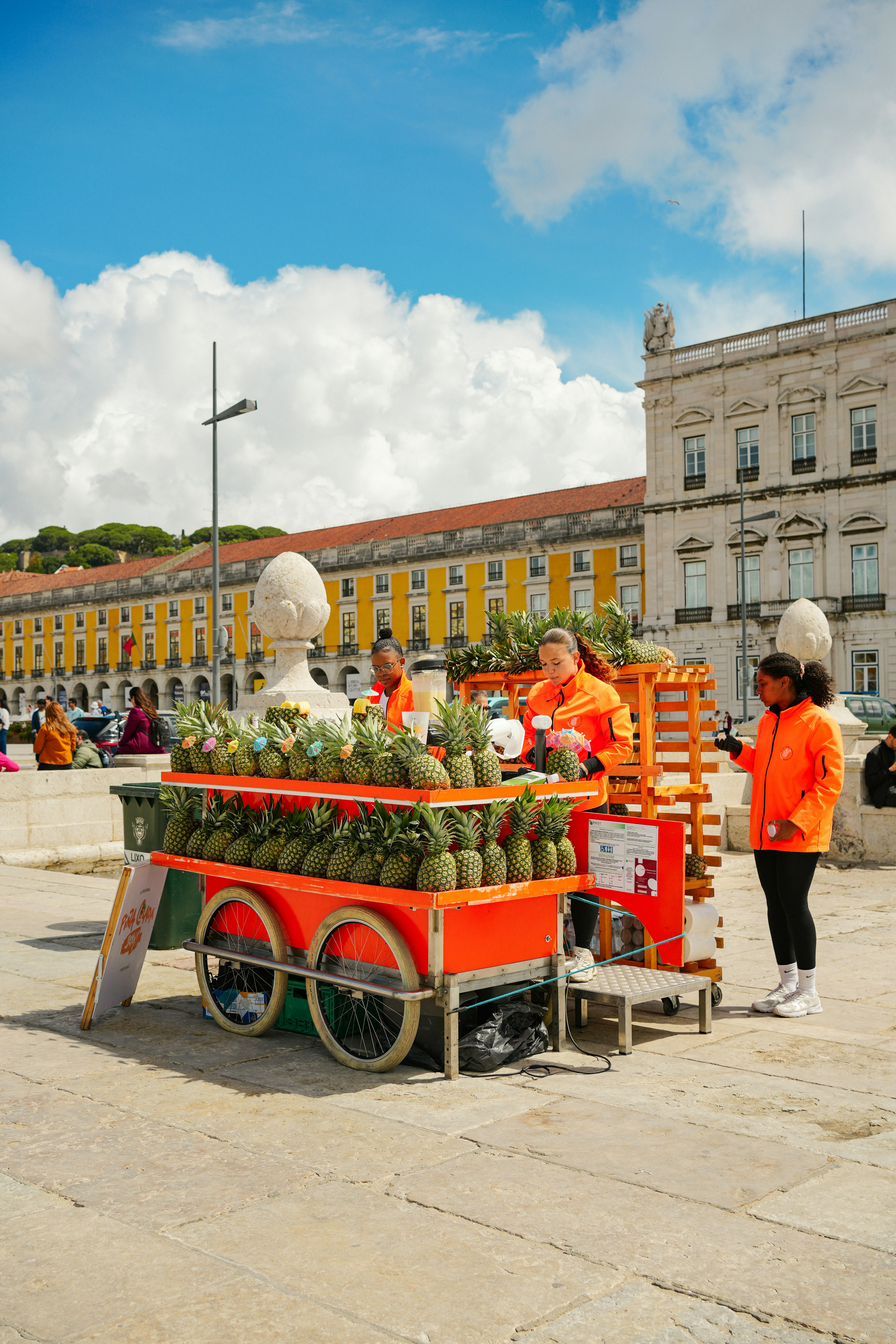 Orange Pineapple Cart in Sunlit Plaza