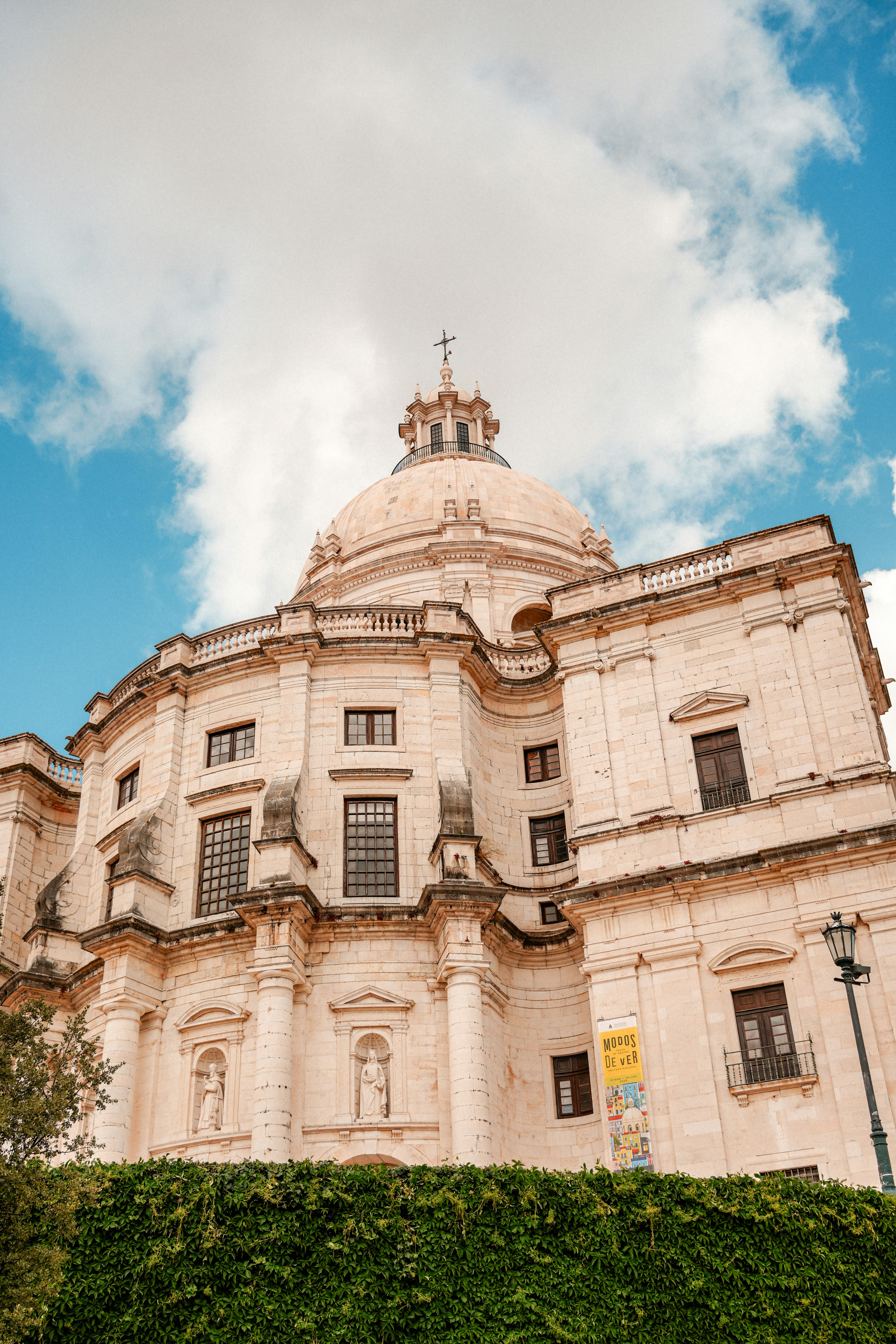 Dome Overlook: The Baroque Facade Rising Above Green Hedge