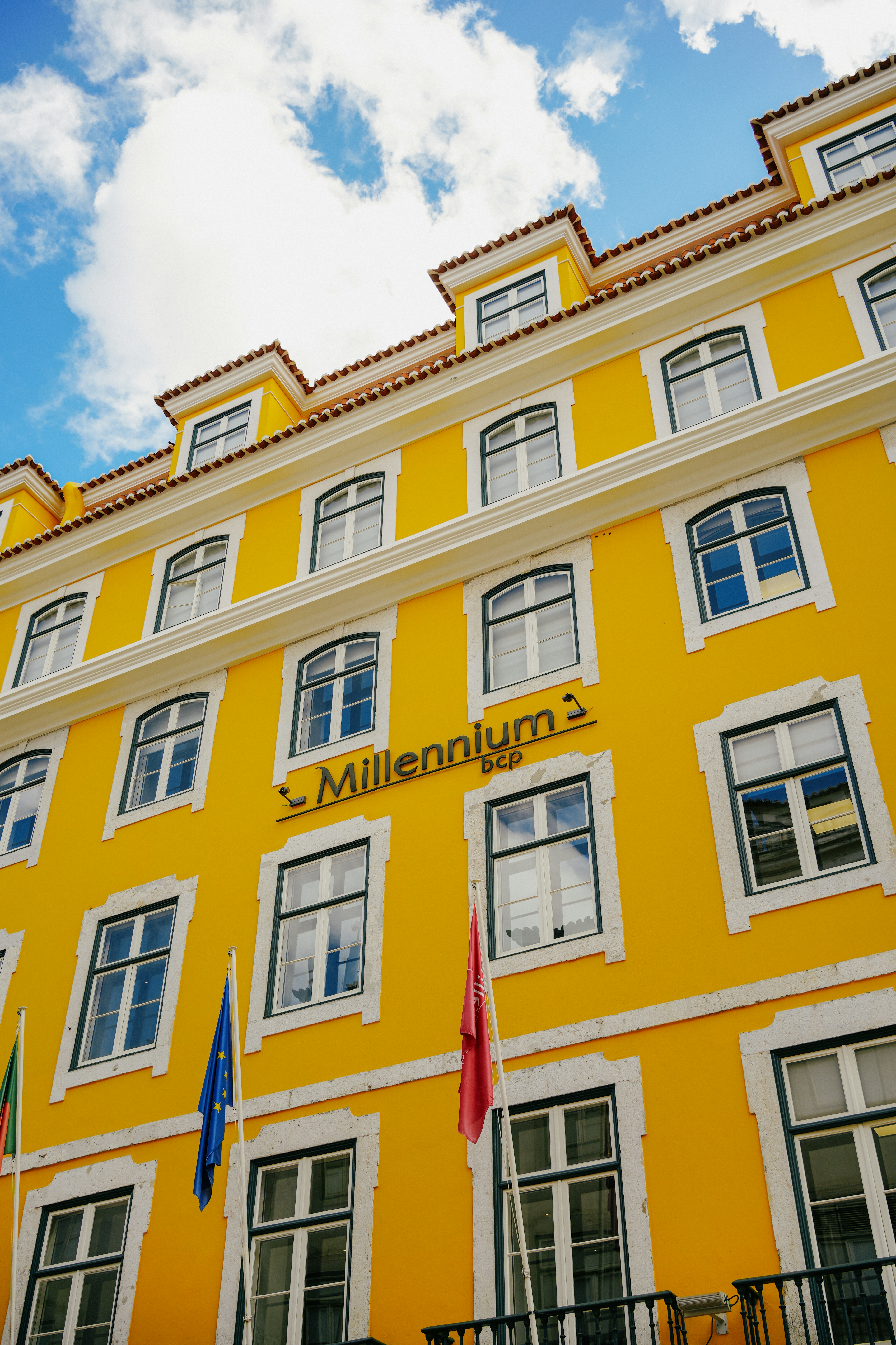 Sunlit Yellow Facade of Millennium House with Cresting Gables