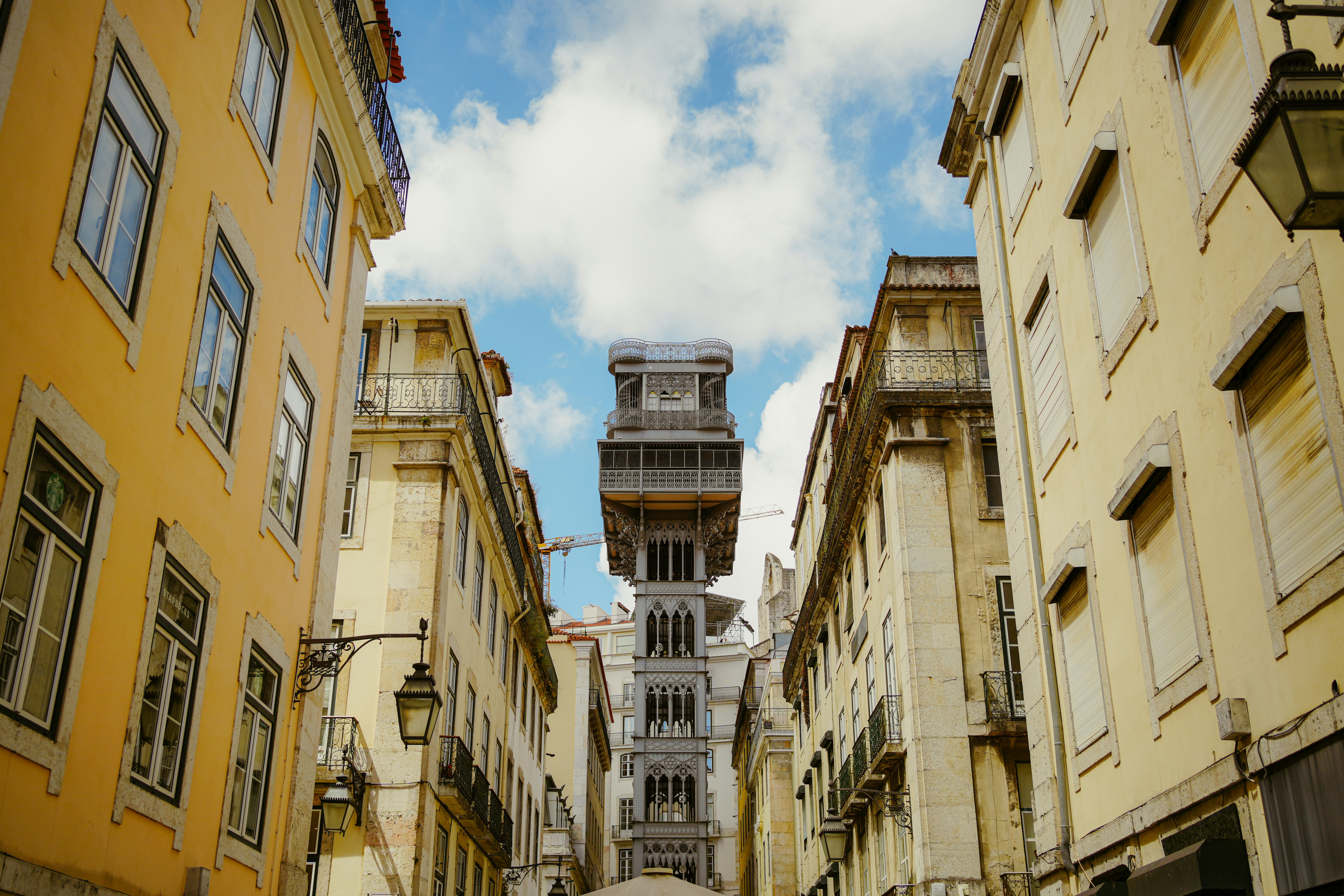 Towering Elevator of Stone: A Narrow Street Framing the Santa Justa-like Core