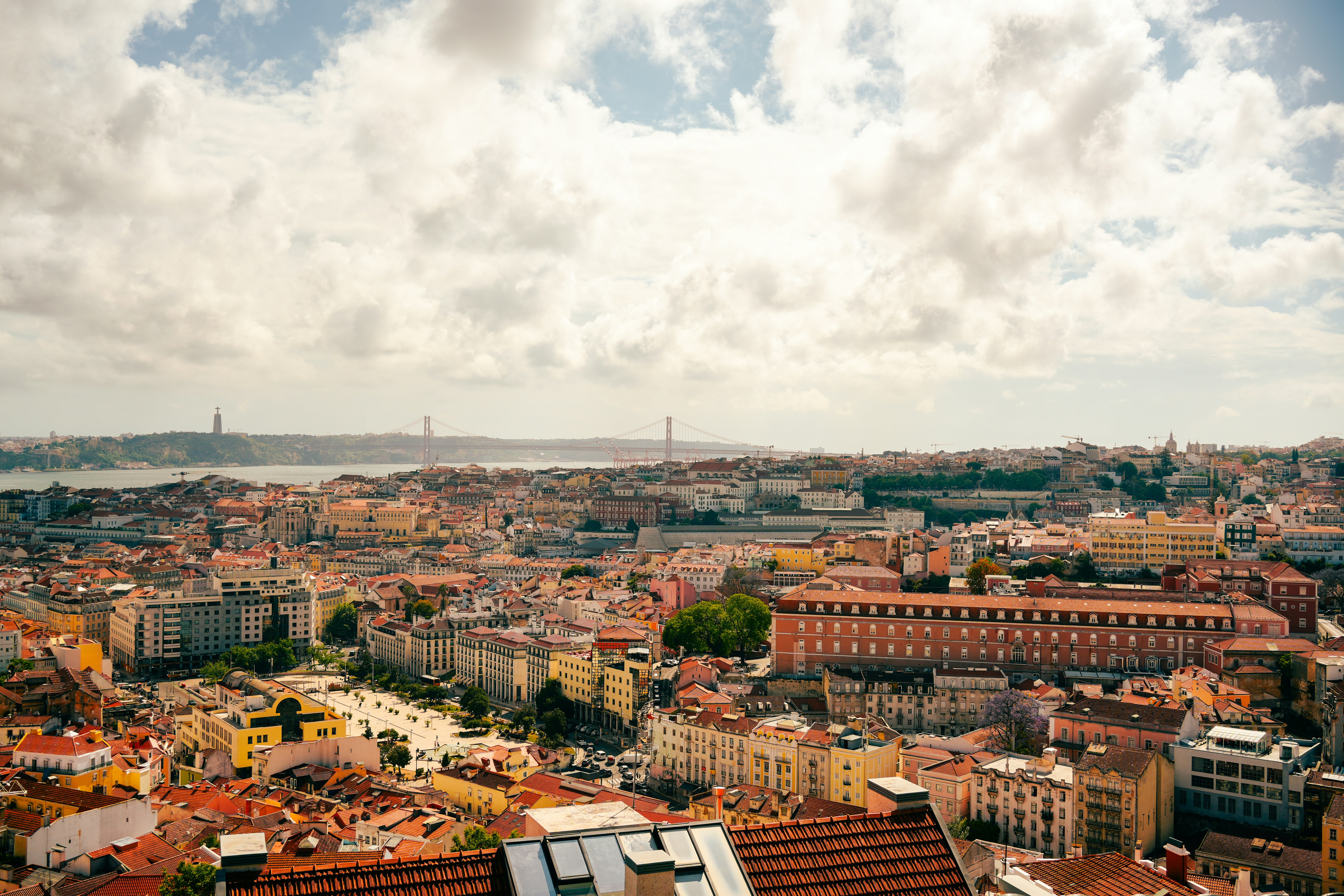 Sunlit Seaside Cityscape: A Rooftop Panorama Across a Terracotta- tiled Horizon