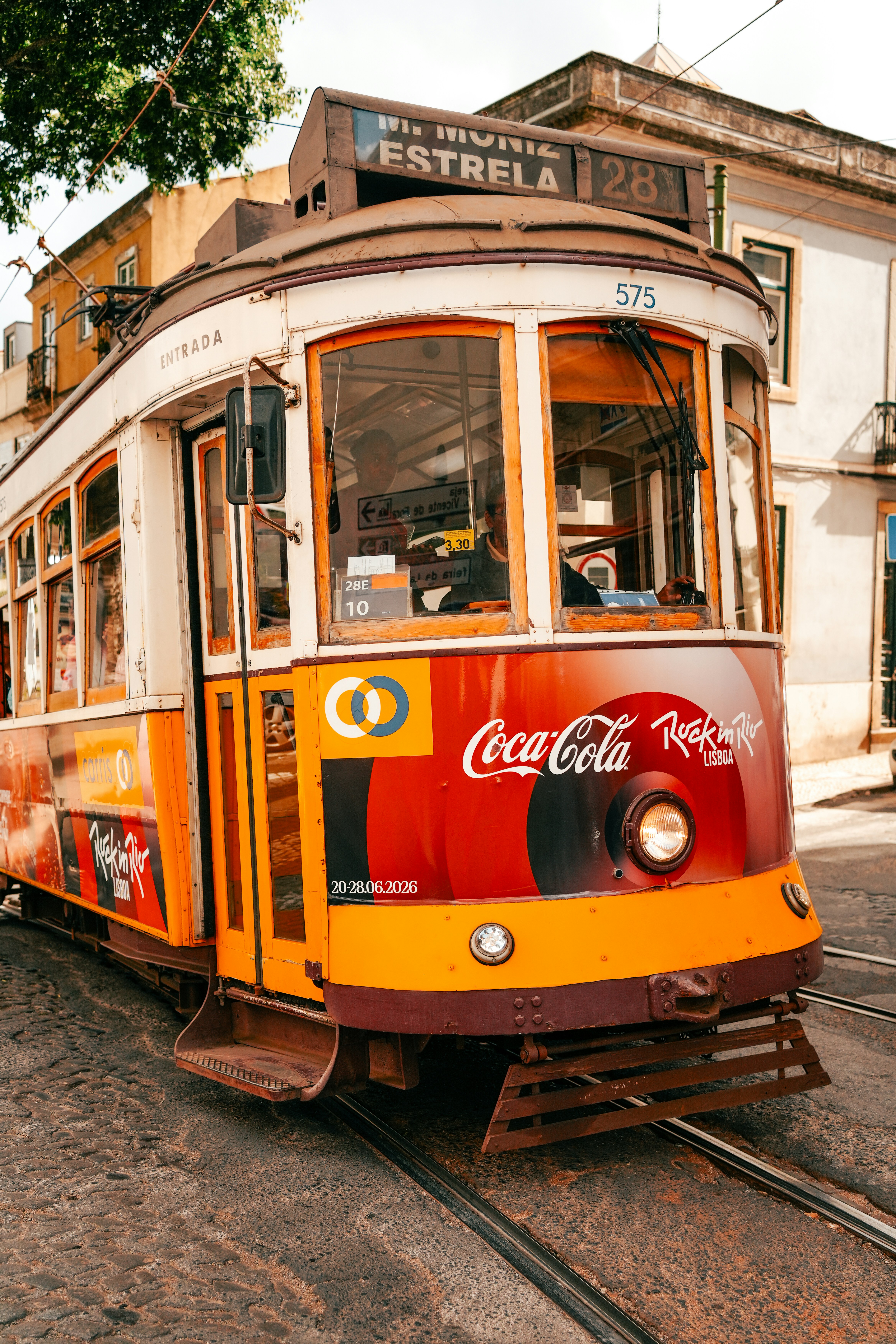 Vibrant Streetcar on a Sunlit Lisbon Lane