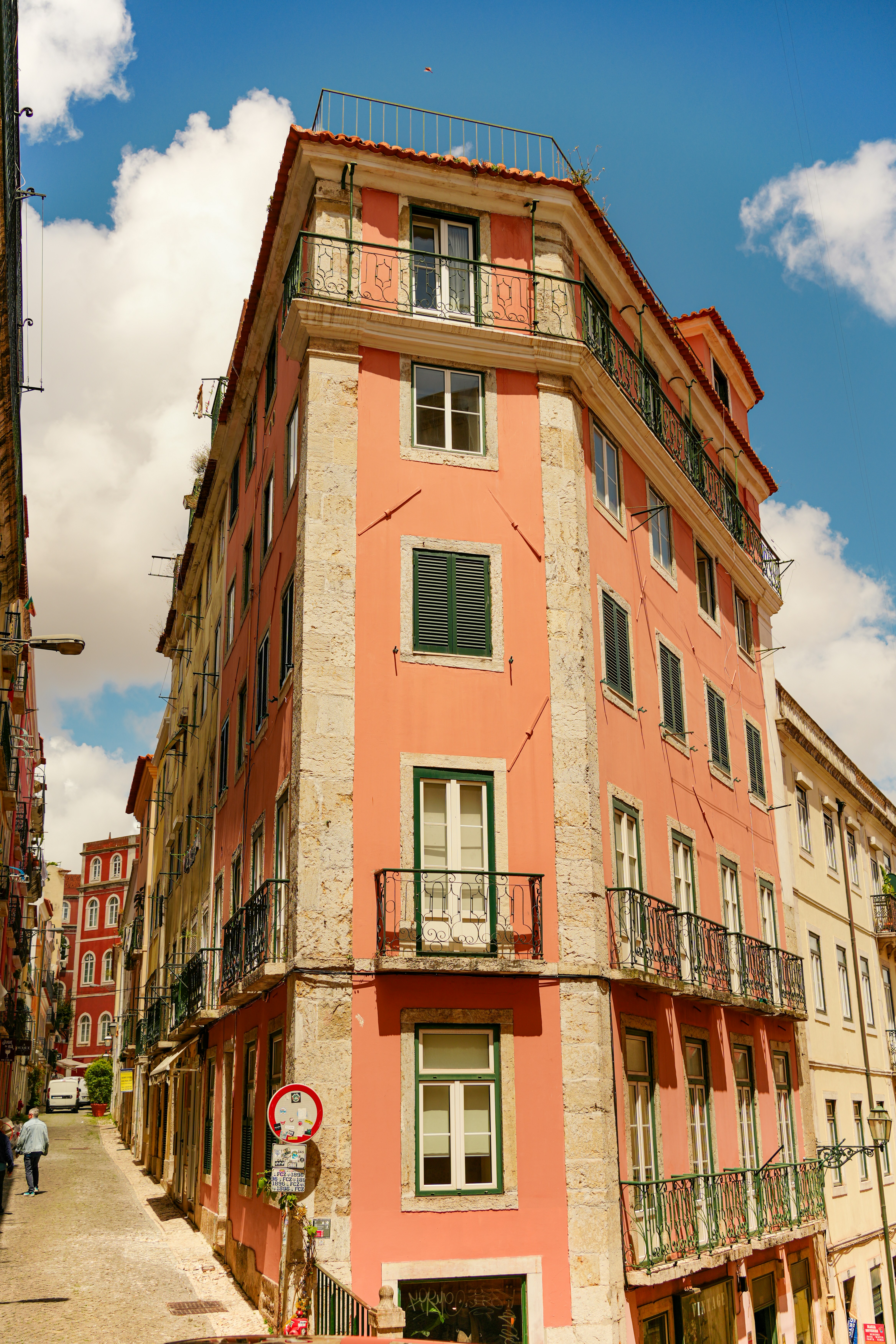 Sunlit Coral Building Anchored in a European Street