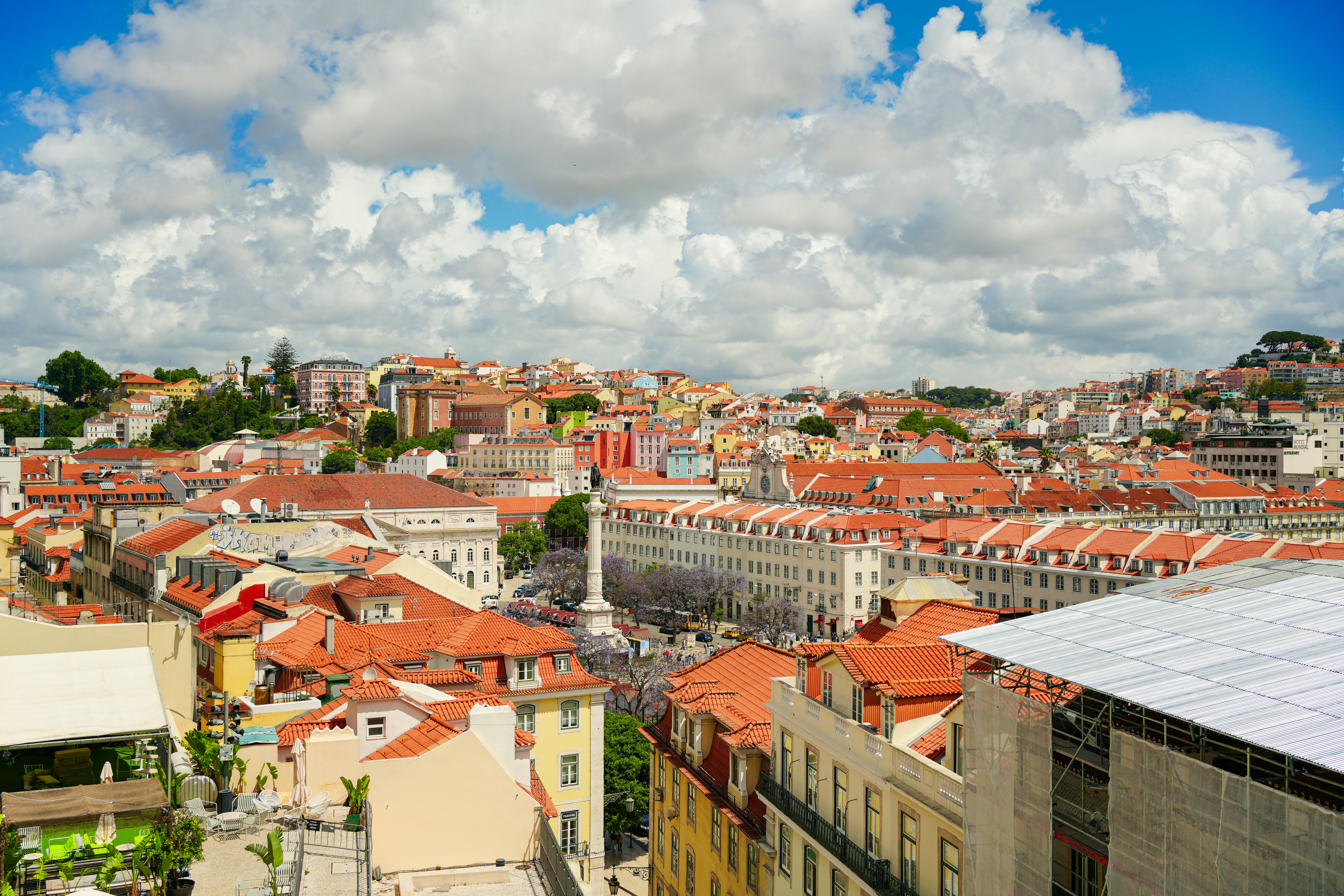 Crimson rooftops and a sunlit skyline in a coastal European town